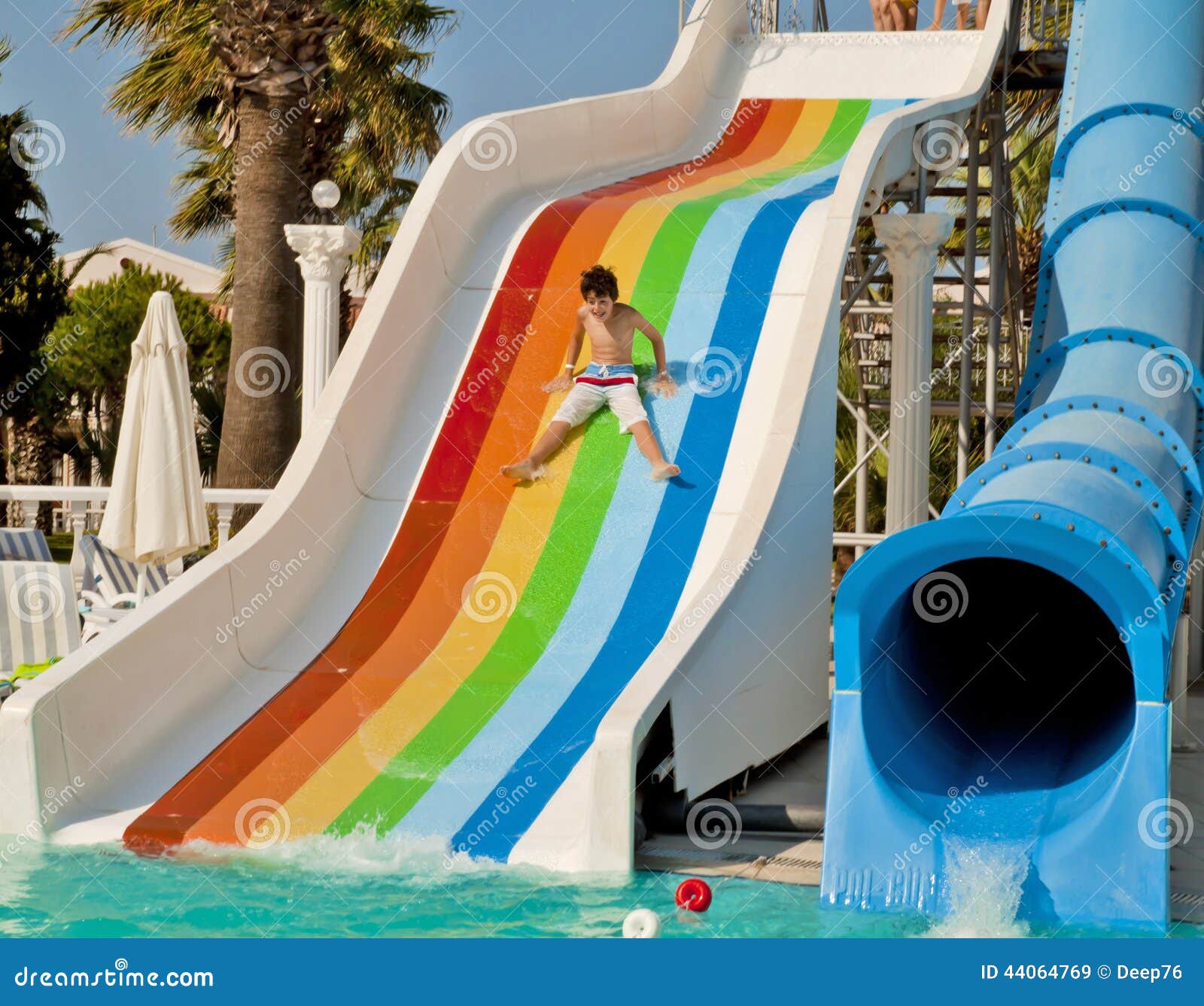 Boy on slide at waterpark stock image. Image of child - 44064769