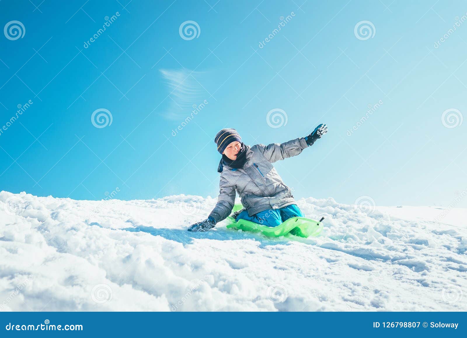 Boy Slides Down from the Snow Slope. Enjoying the Winter Sledding Time ...