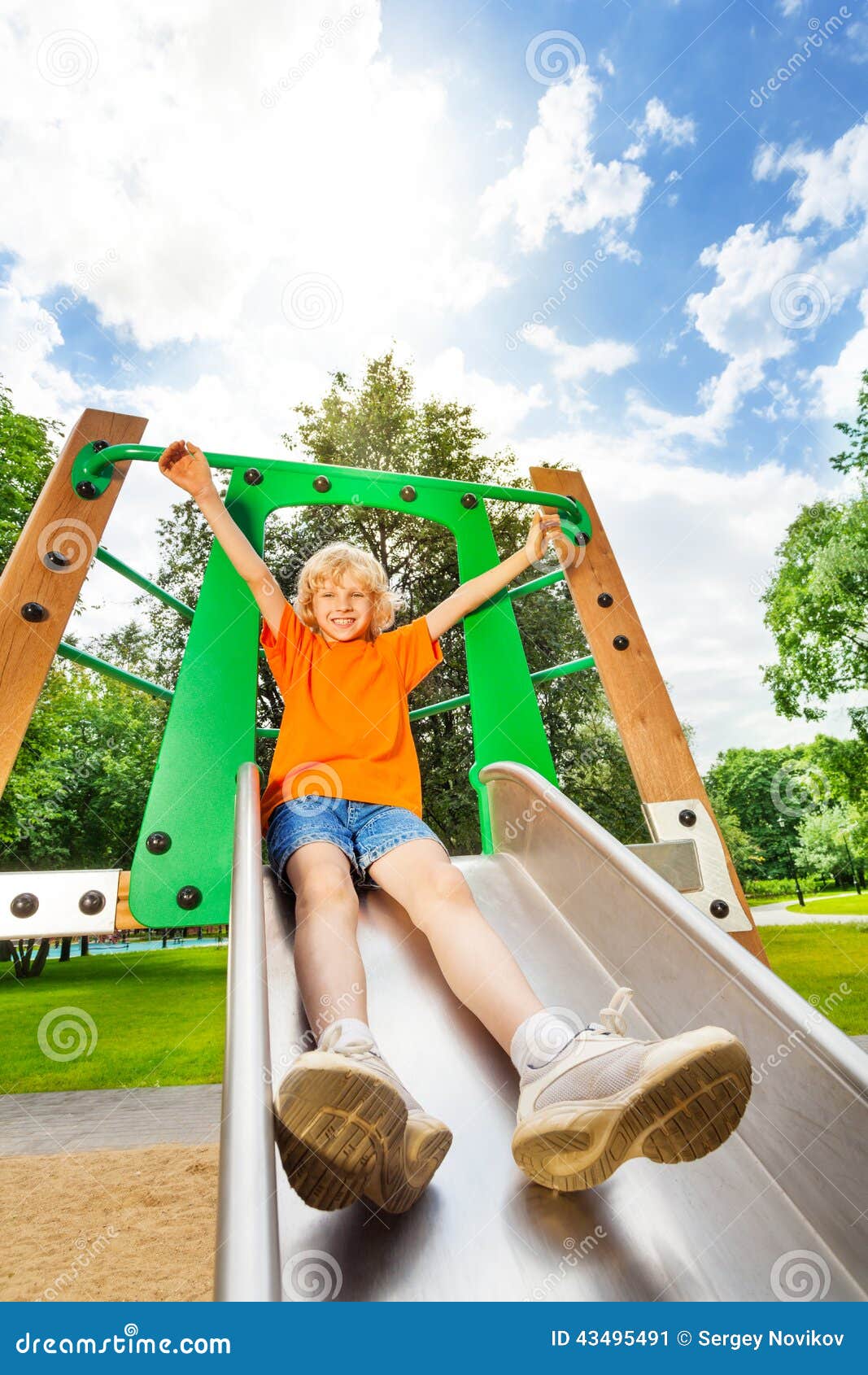 Boy Sliding on Metallic Chute with Hands Up Stock Image - Image of ...