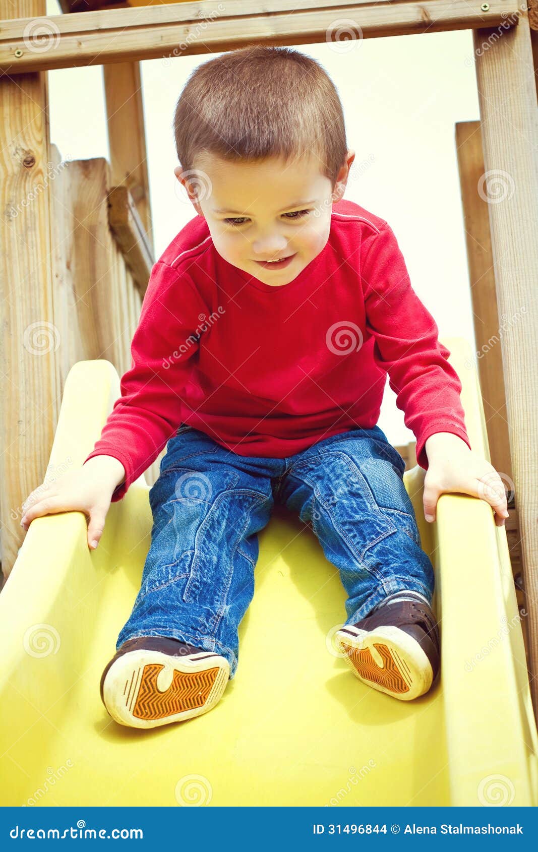Boy sliding on playground stock photo. Image of childhood - 31496844