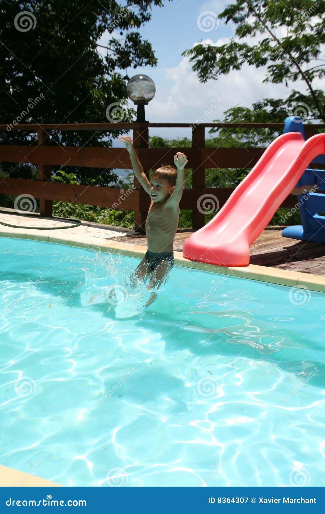 Boy sliding in the pool stock image. Image of cute, teach - 8364307