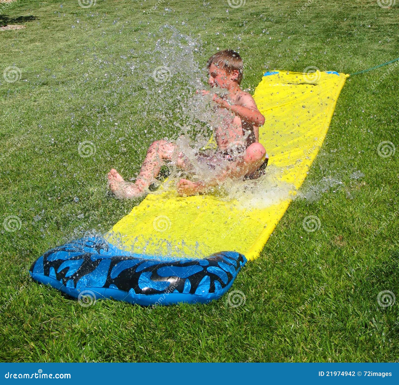 Boy Sliding through Water stock photo. Image of happy - 21974942