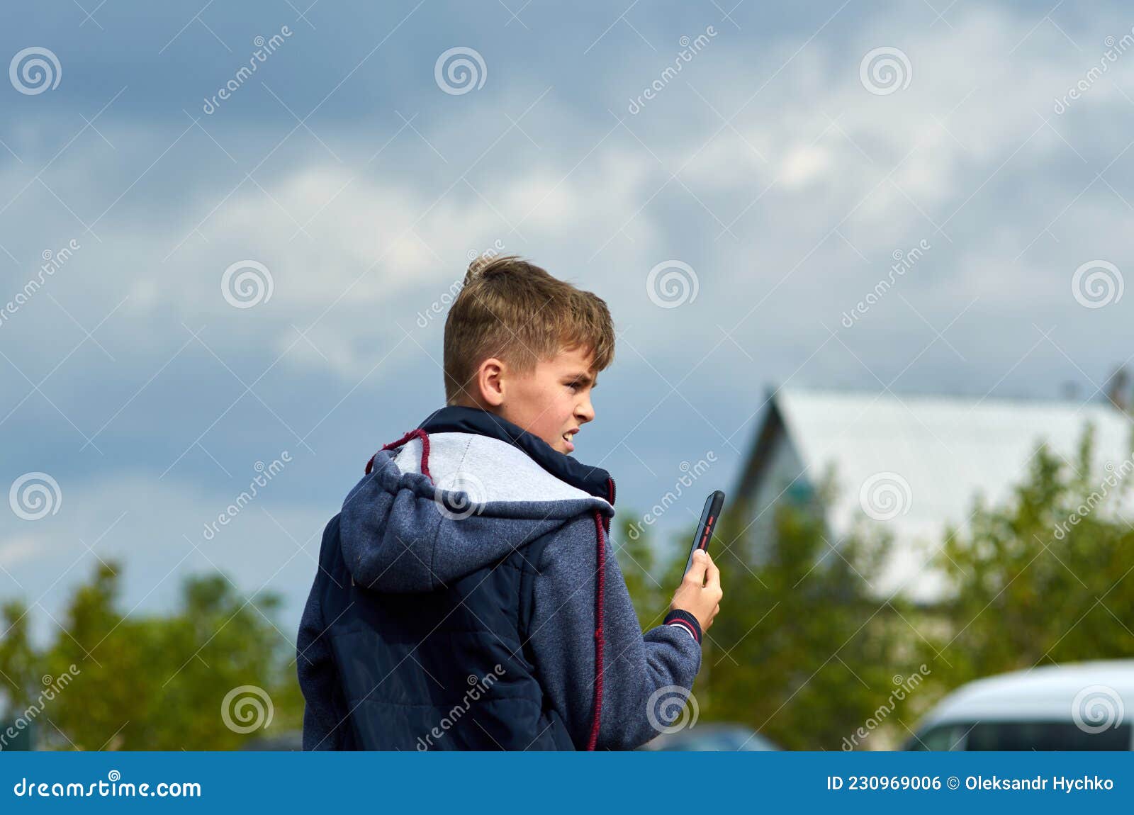 A Boy with Smartphone Watching the Competition Stock Photo - Image of ...