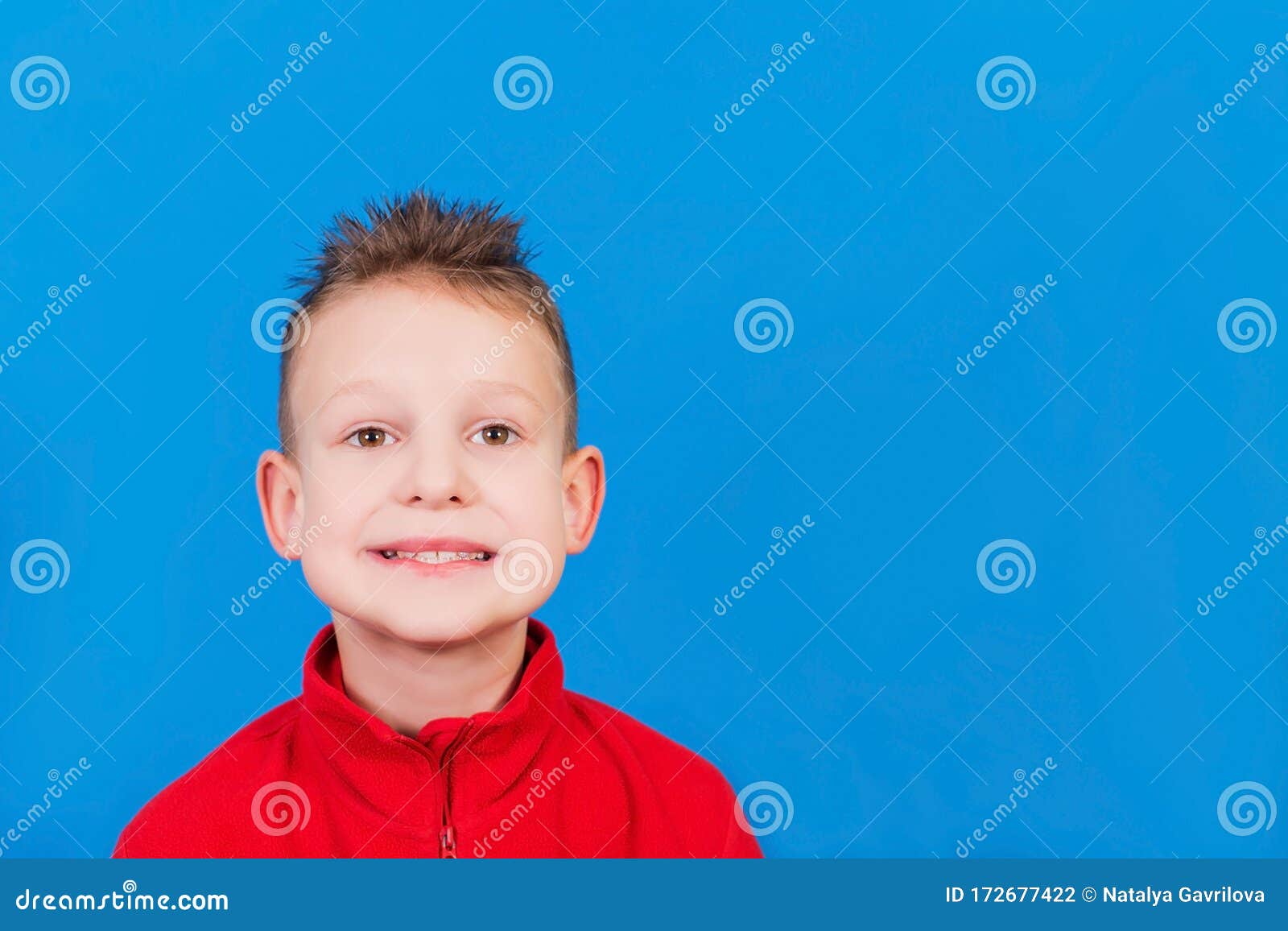 Boy is Smiling on a Blue Background Stock Photo - Image of cute ...