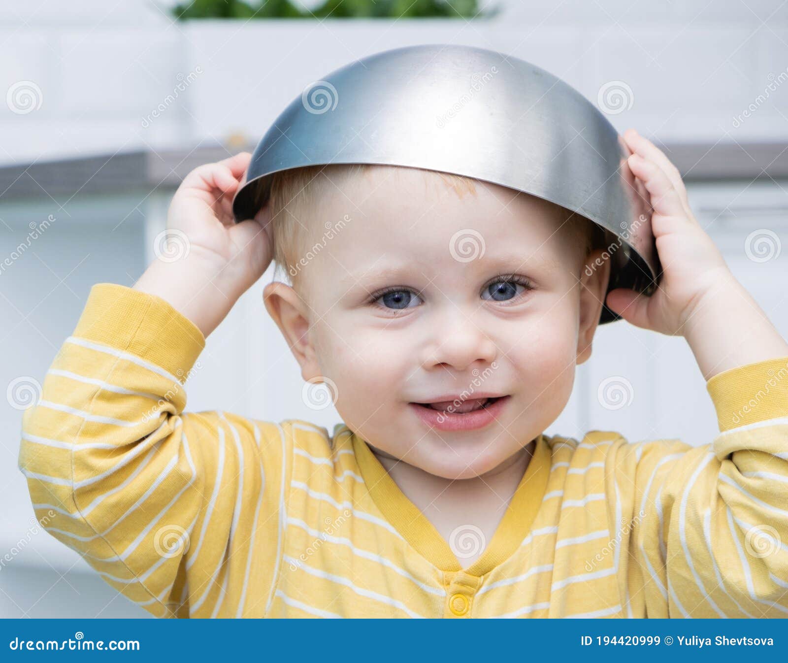 Boy Smiling with a Bowl on His Head. Games in the Kitchen. Stock Image ...