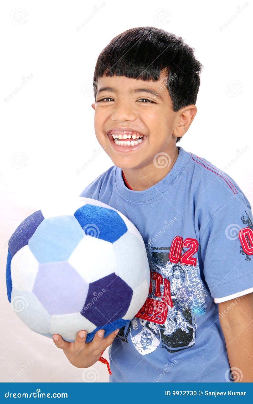 Boy Smiling with a Football Stock Photo - Image of happy, indoor: 9972730
