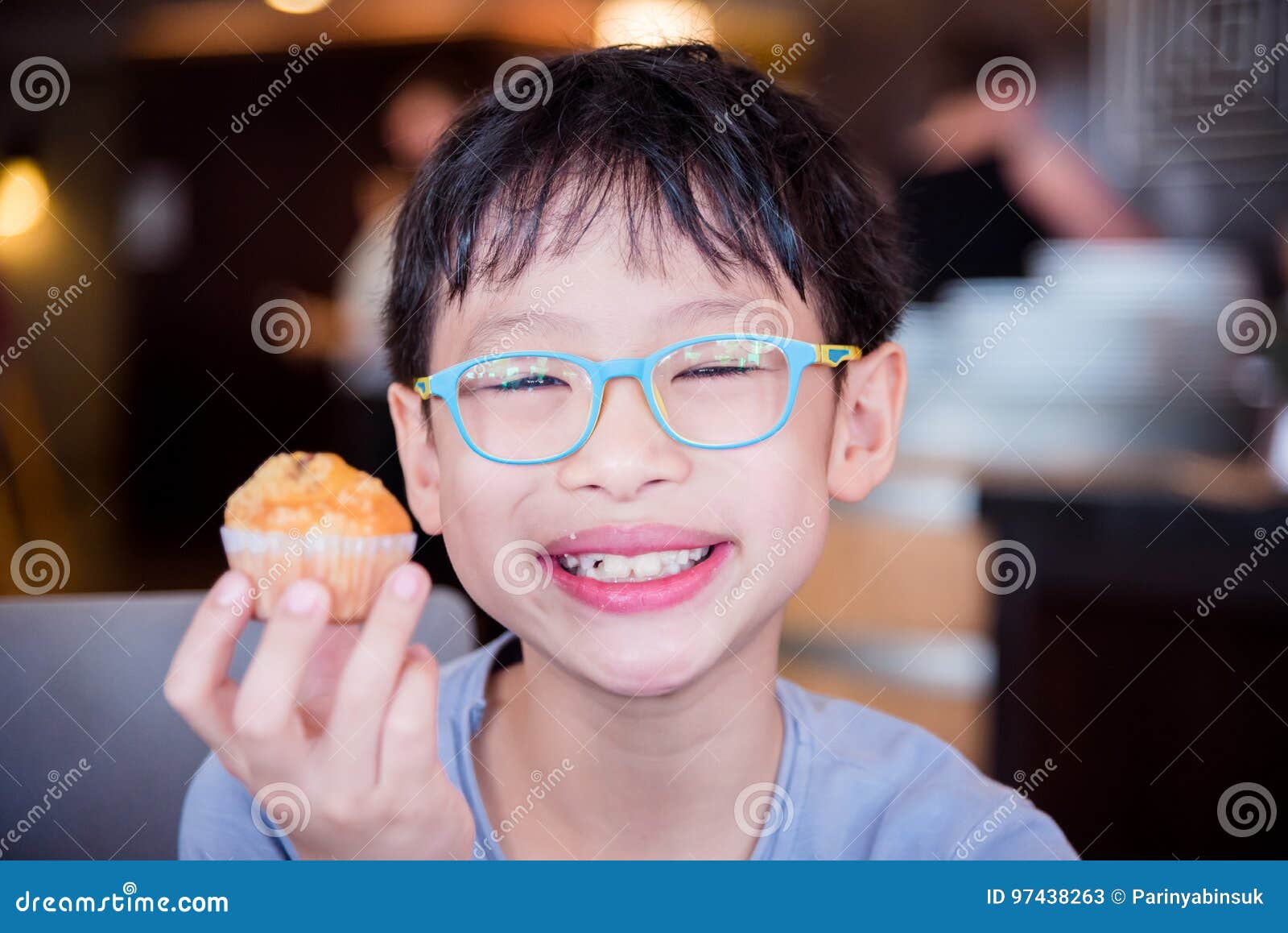Boy Smiling while Holding a Muffin in His Hand. Stock Image - Image of ...