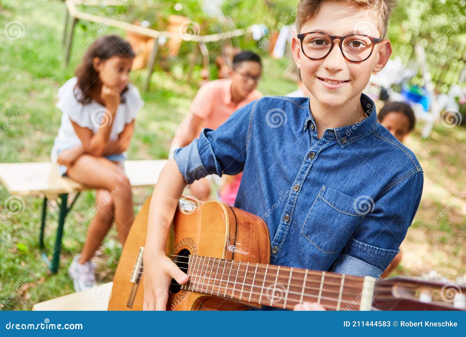 Boy Smiling while Playing Guitar in Talent Show Stock Image - Image of ...