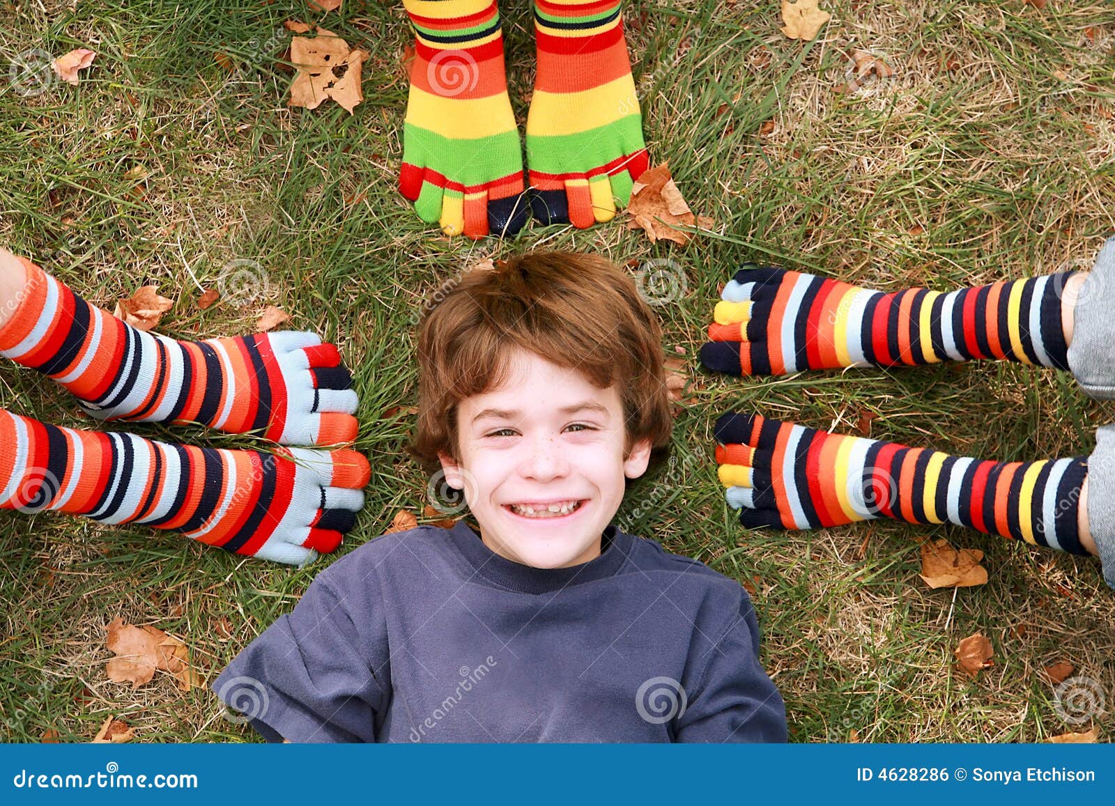 Boy Smiling Surrounded by Toe Socks Stock Photo - Image of close ...