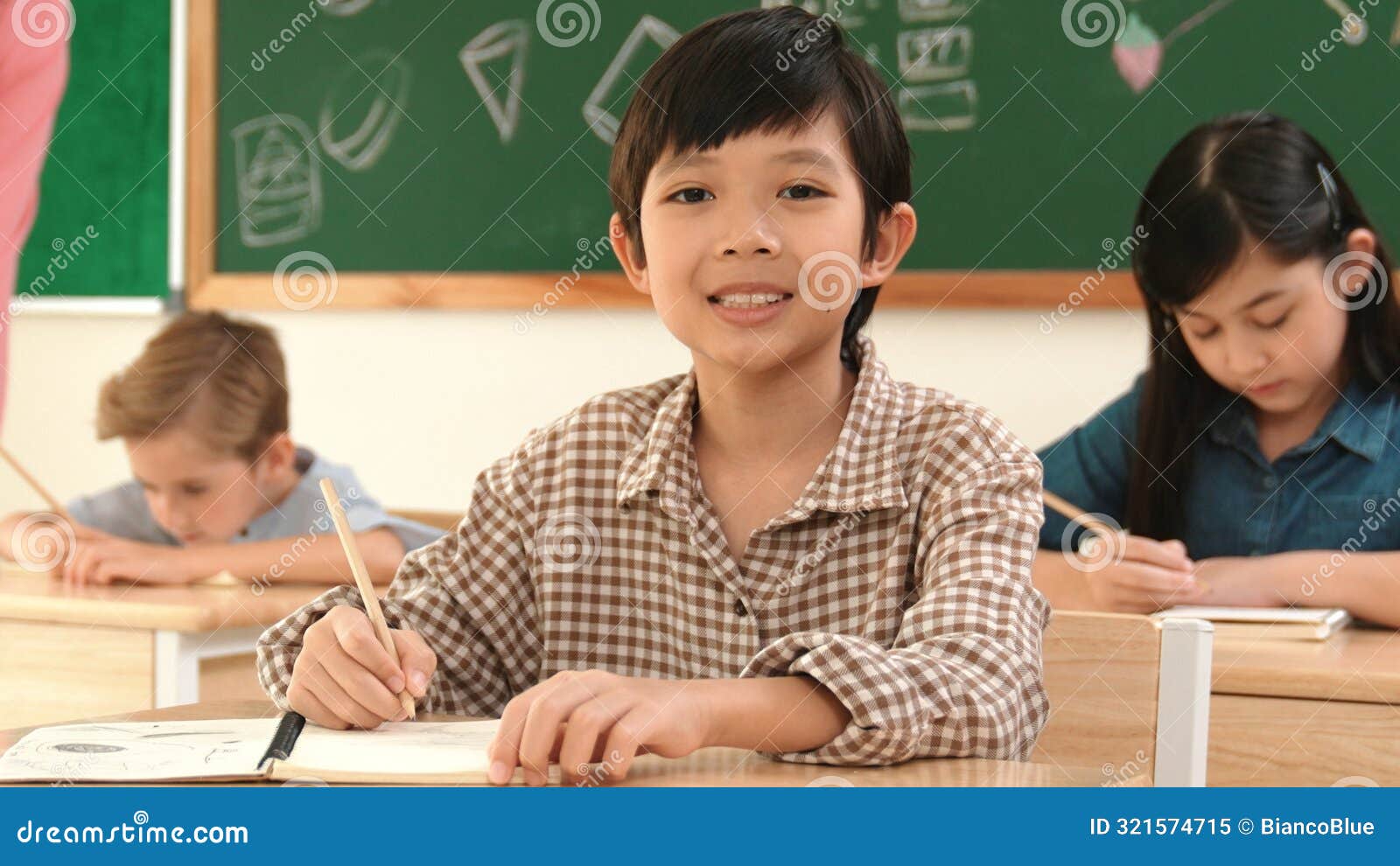 Boy Smiling To Camera while Student Writing Answer in Answer Sheet ...