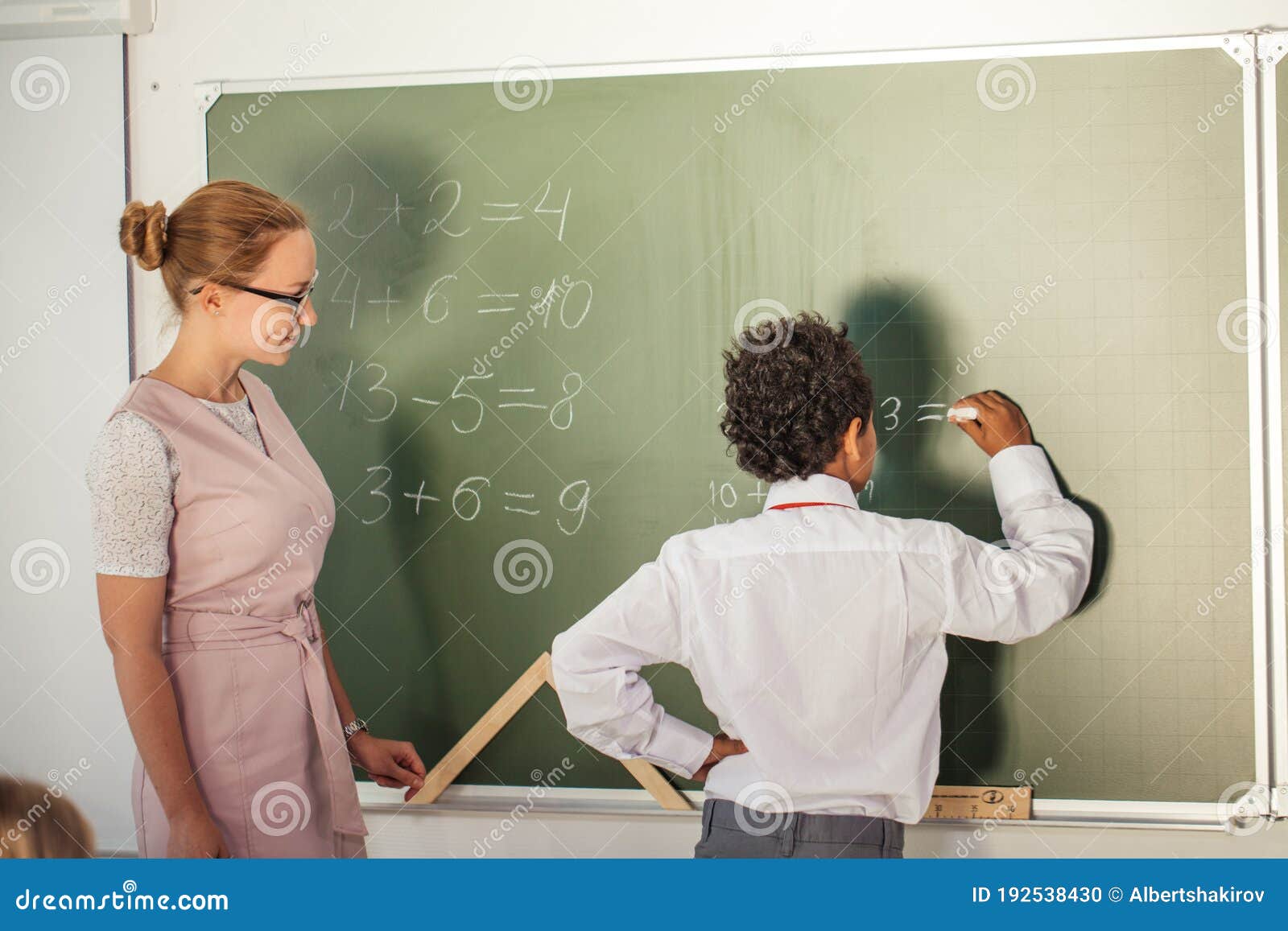 Boy Solving Addition And Subtraction On Board. Schoolboy Writing ...