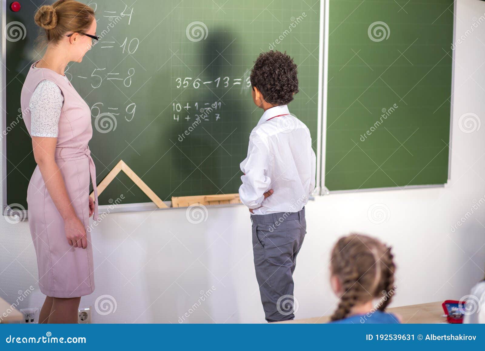 Boy Solving Addition and Subtraction on Board. Schoolboy Writing ...