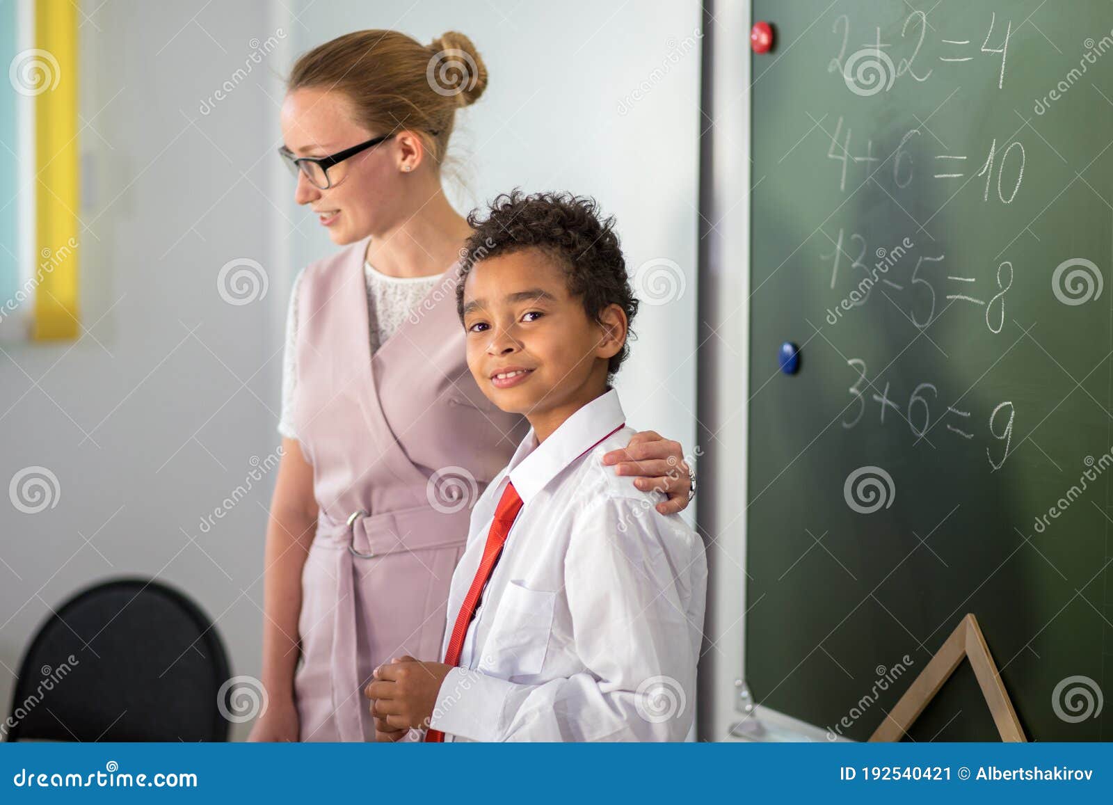 Boy Solving Addition And Subtraction On Board. Schoolboy Writing ...