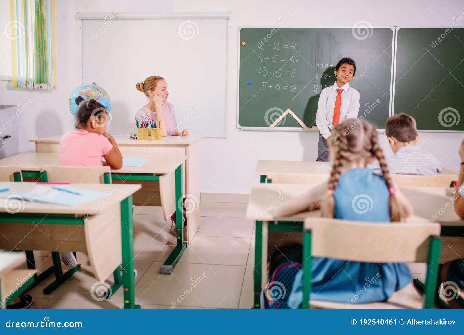 Boy Solving Addition And Subtraction On Board. Schoolboy Writing ...