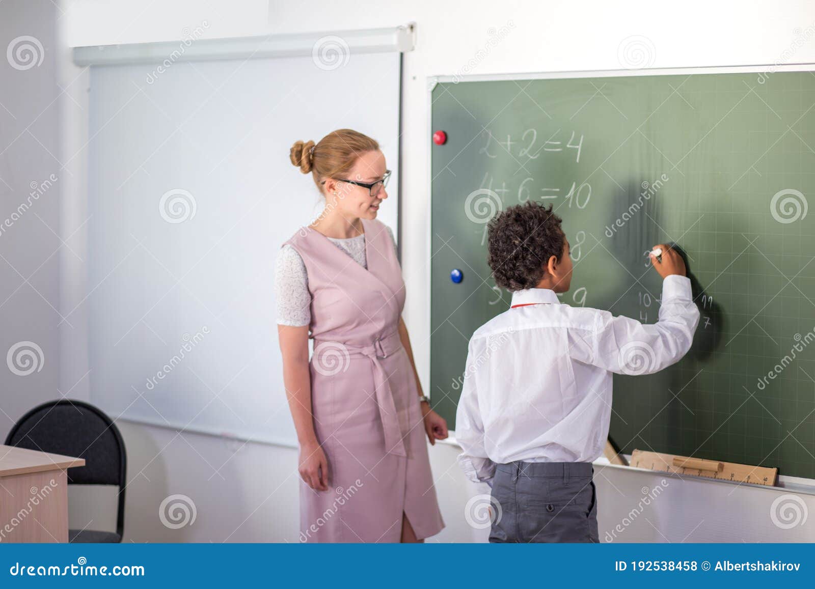 Boy Solving Addition And Subtraction On Board. Schoolboy Writing ...