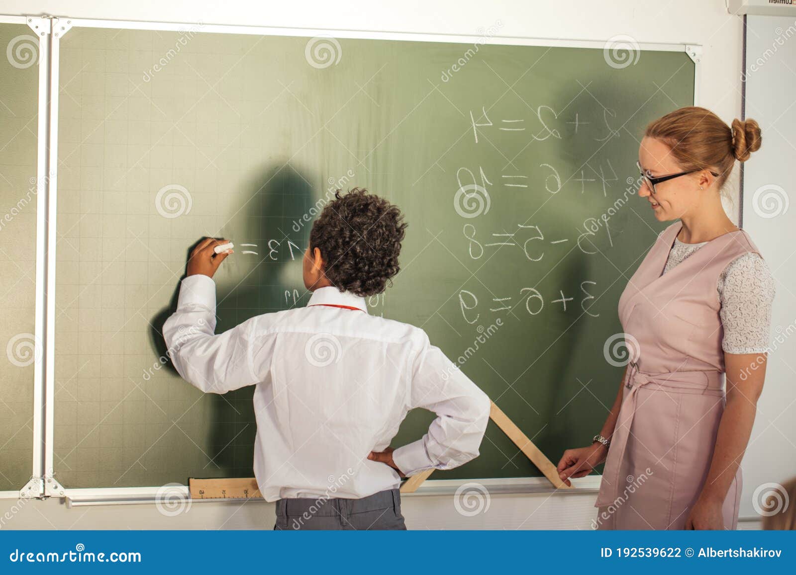 Boy Solving Addition And Subtraction On Board. Schoolboy Writing ...