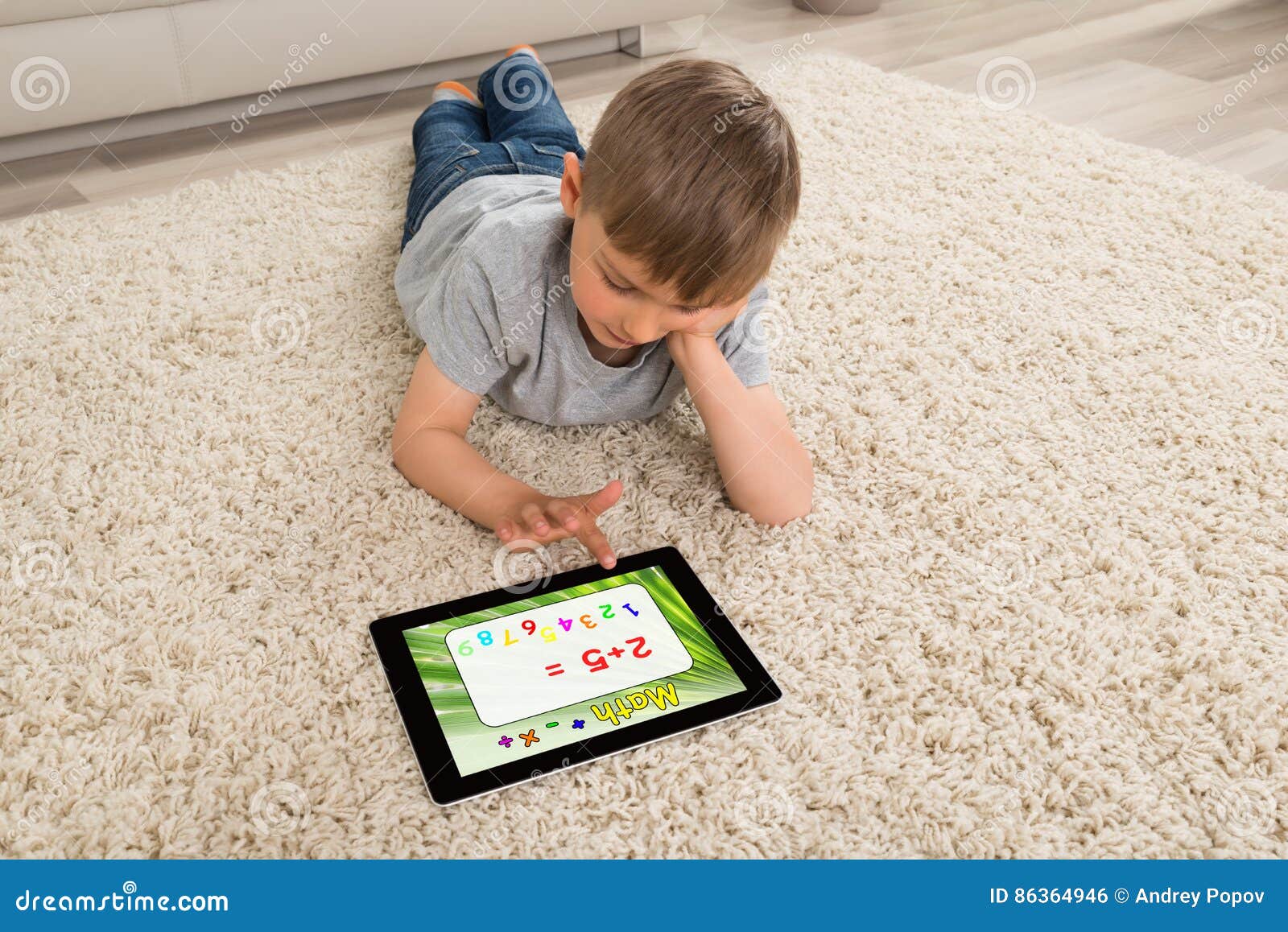Boy Solving Math Problem on Digital Tablet Stock Photo - Image of lying ...