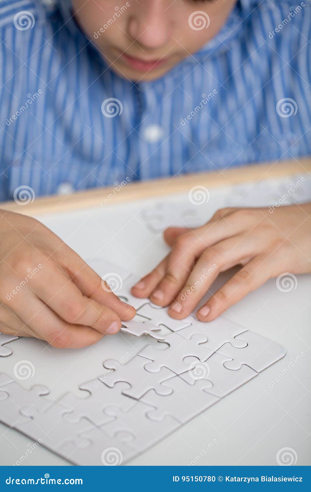 Boy solving a puzzle stock photo. Image of oversensitivity - 95150780