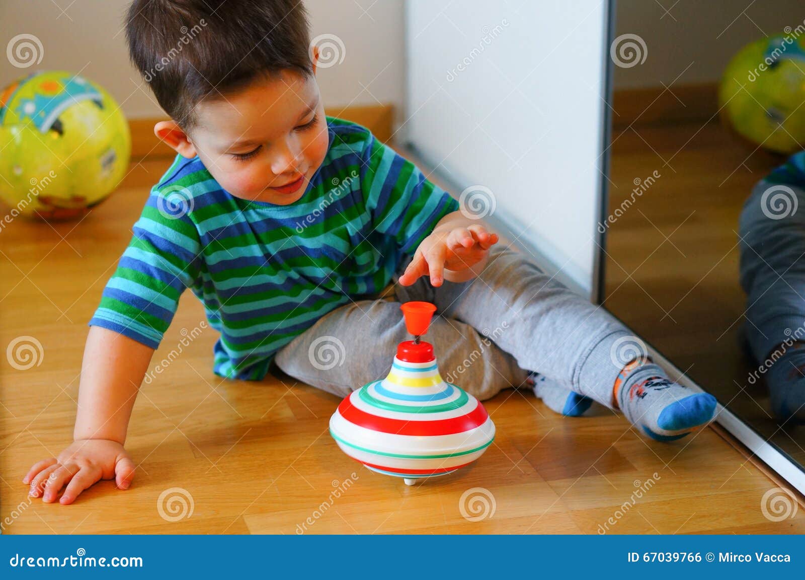 Boy and spin top stock photo. Image of child, indoor - 67039766