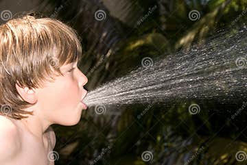 Boy spitting water stock image. Image of fountain, play - 5238701