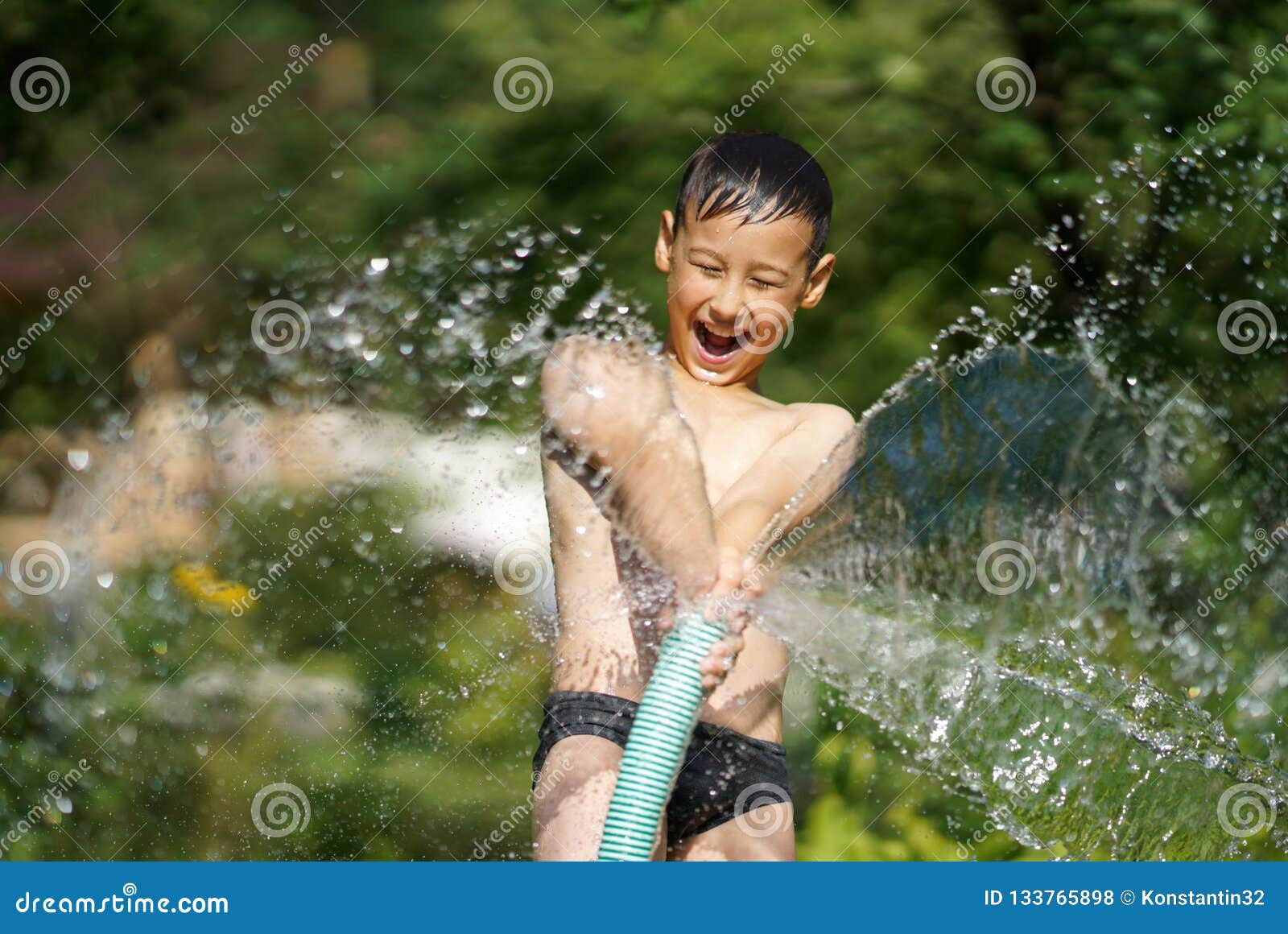 The Boy with Splash Water in Hot Summer Day Outdoors Stock Photo ...