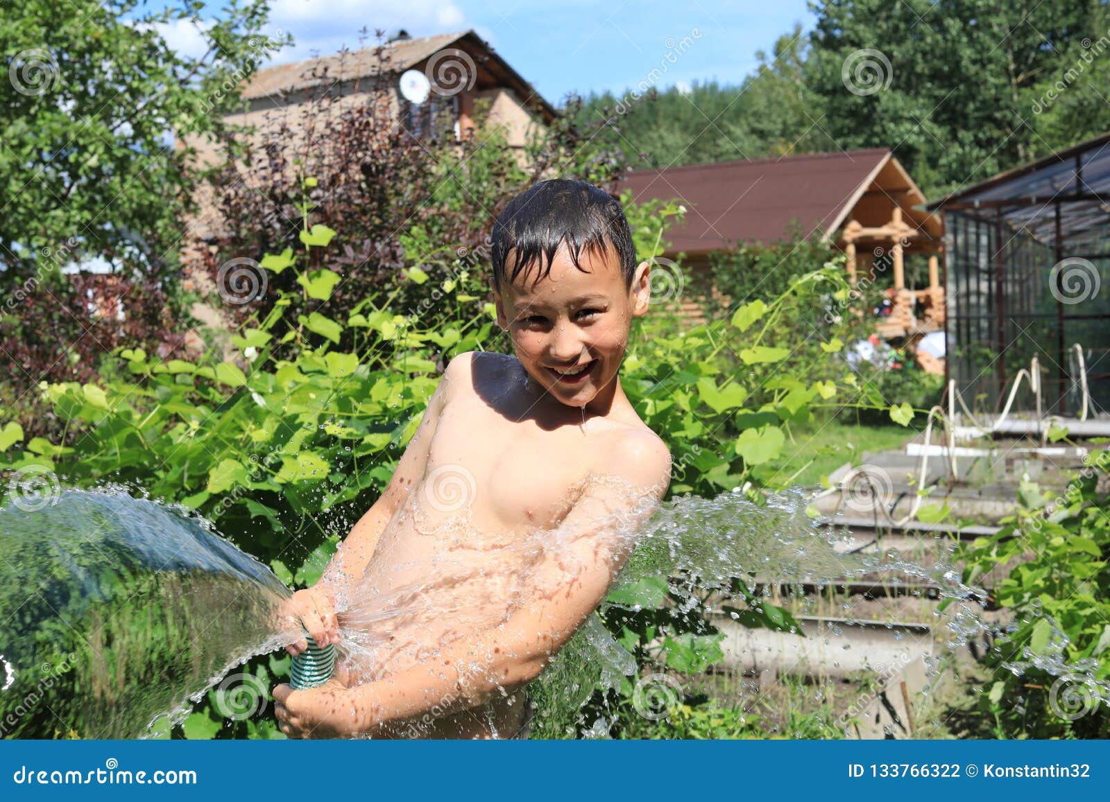 The Boy with Splash Water in Hot Summer Day Outdoors Stock Photo ...