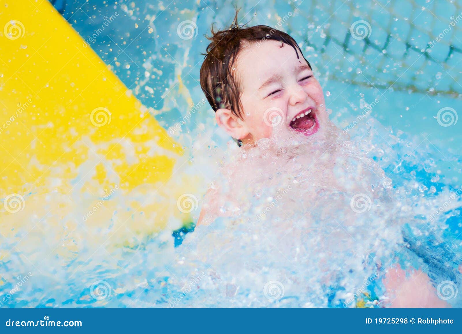 Boy Splashes Down from Water Slide Stock Photo - Image of shallow, hole ...