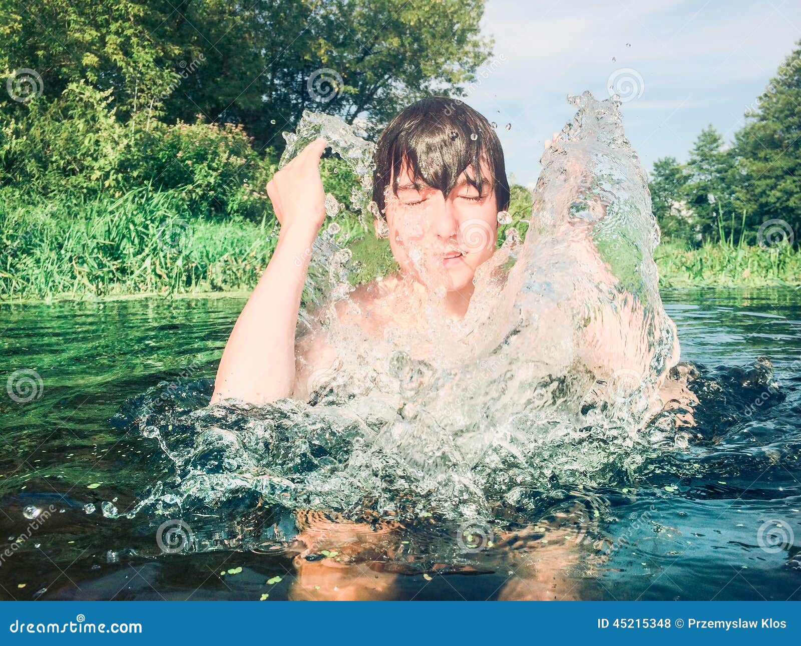 Boy splashing water stock photo. Image of face, lush - 45215348