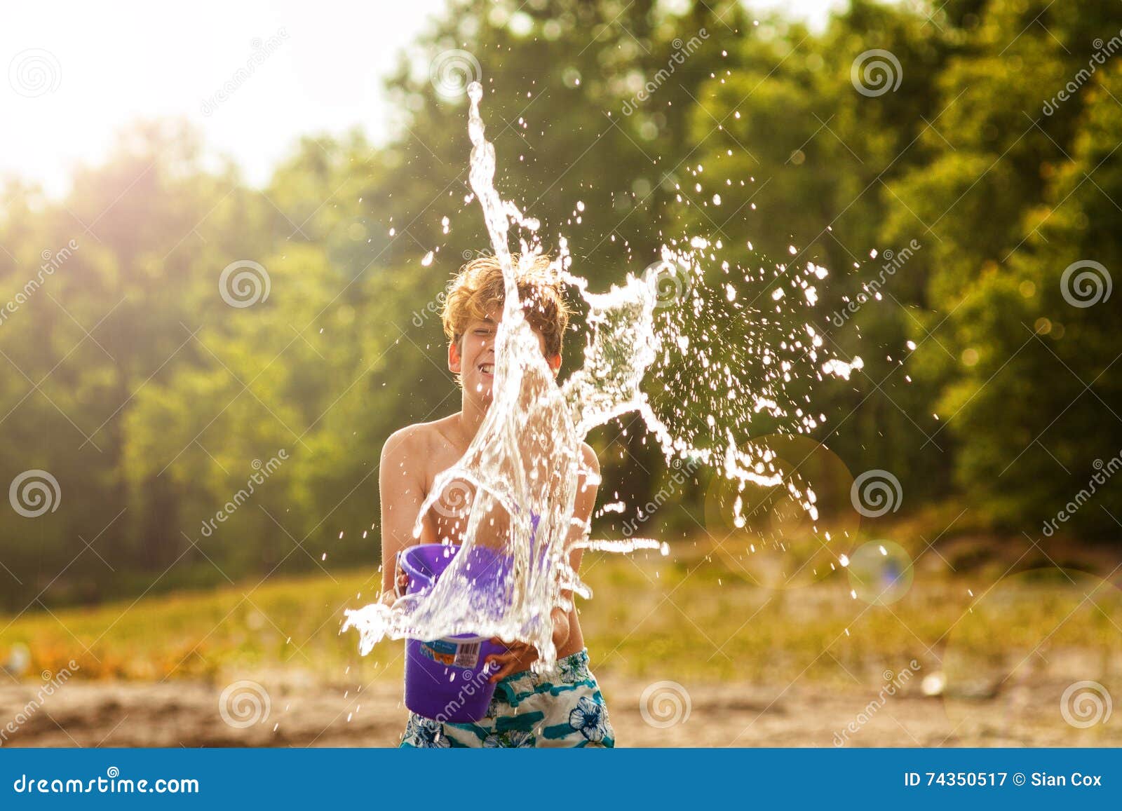 Boy splashing water stock image. Image of summer, play - 74350517