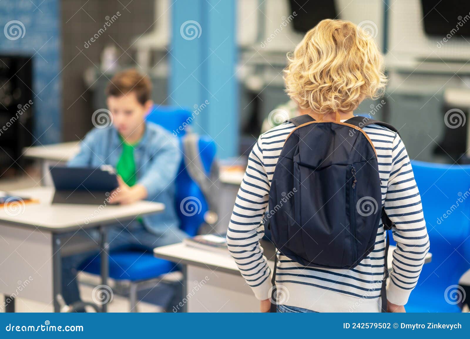 Boy Standing with Back To Camera in Classroom Stock Photo - Image of ...