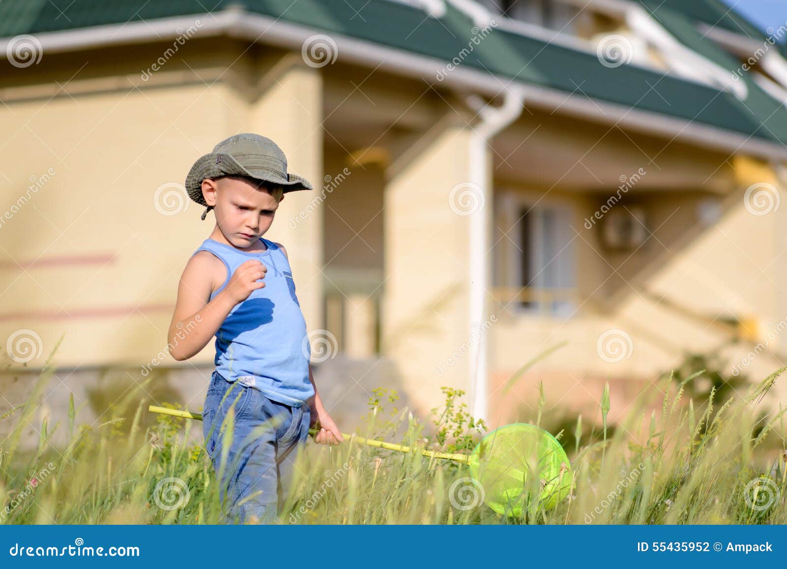 Boy Standing on Lawn in Long Grass with Bug Net Stock Photo - Image of ...