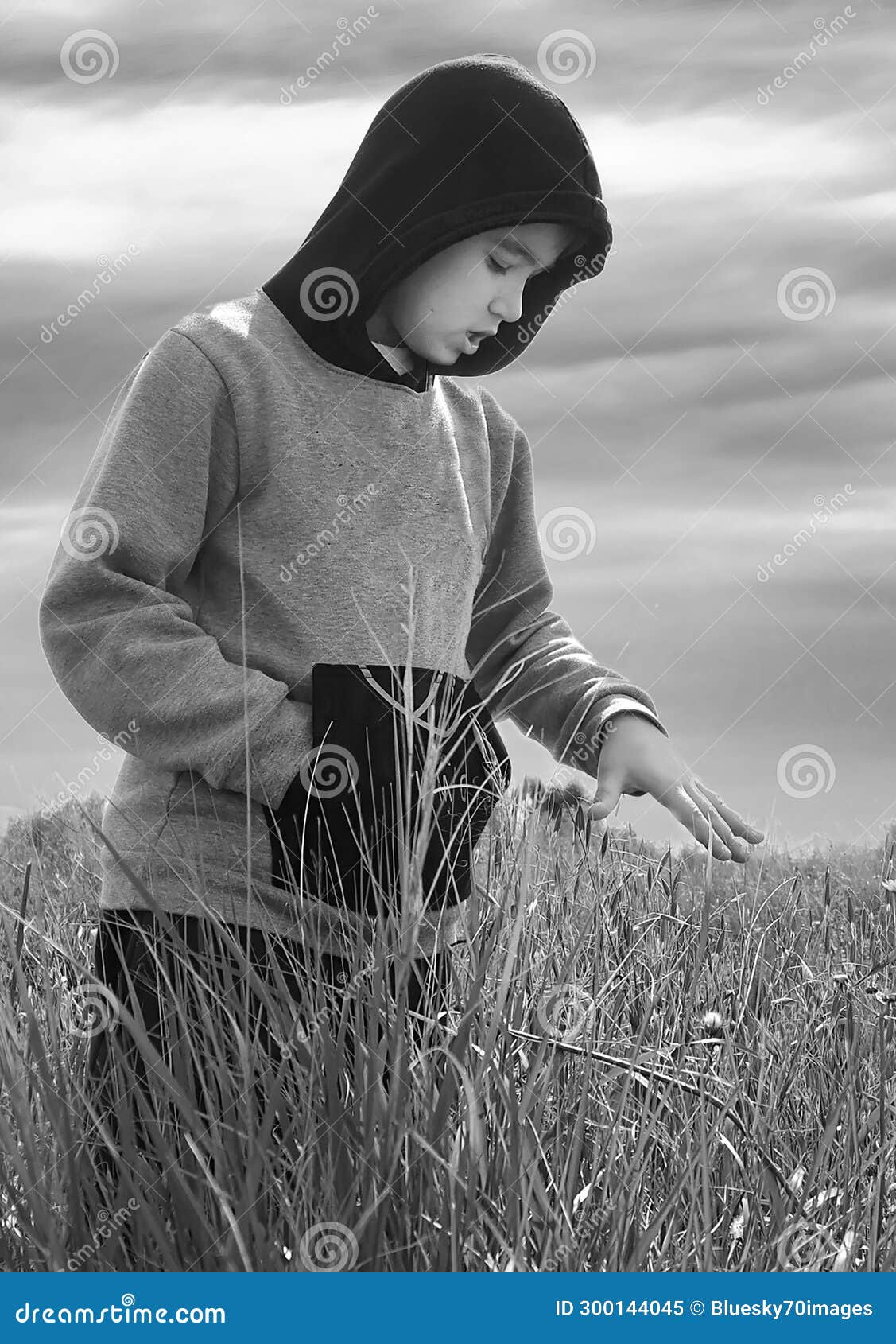 Boy Standing and Looking Down in the Fields . Stock Image - Image of ...
