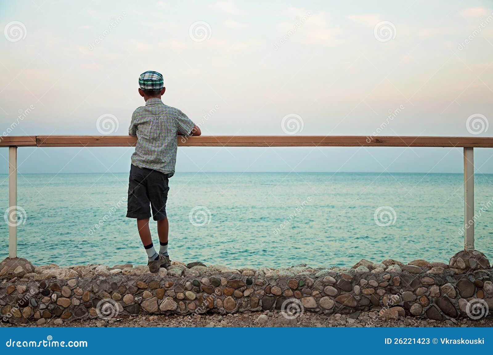 Boy Standing on Quay in the Dusk Looking at Sea Stock Image - Image of ...
