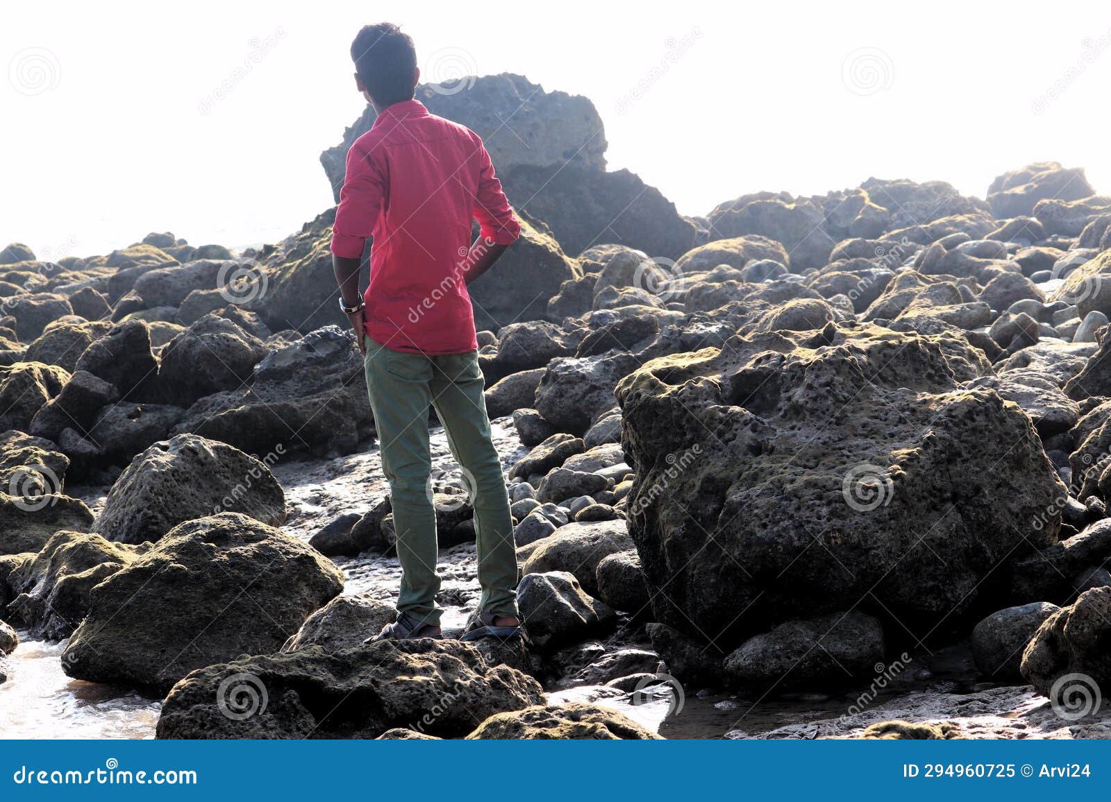 A Boy Standing in a Rock and Looking at the Sea Stock Image - Image of ...