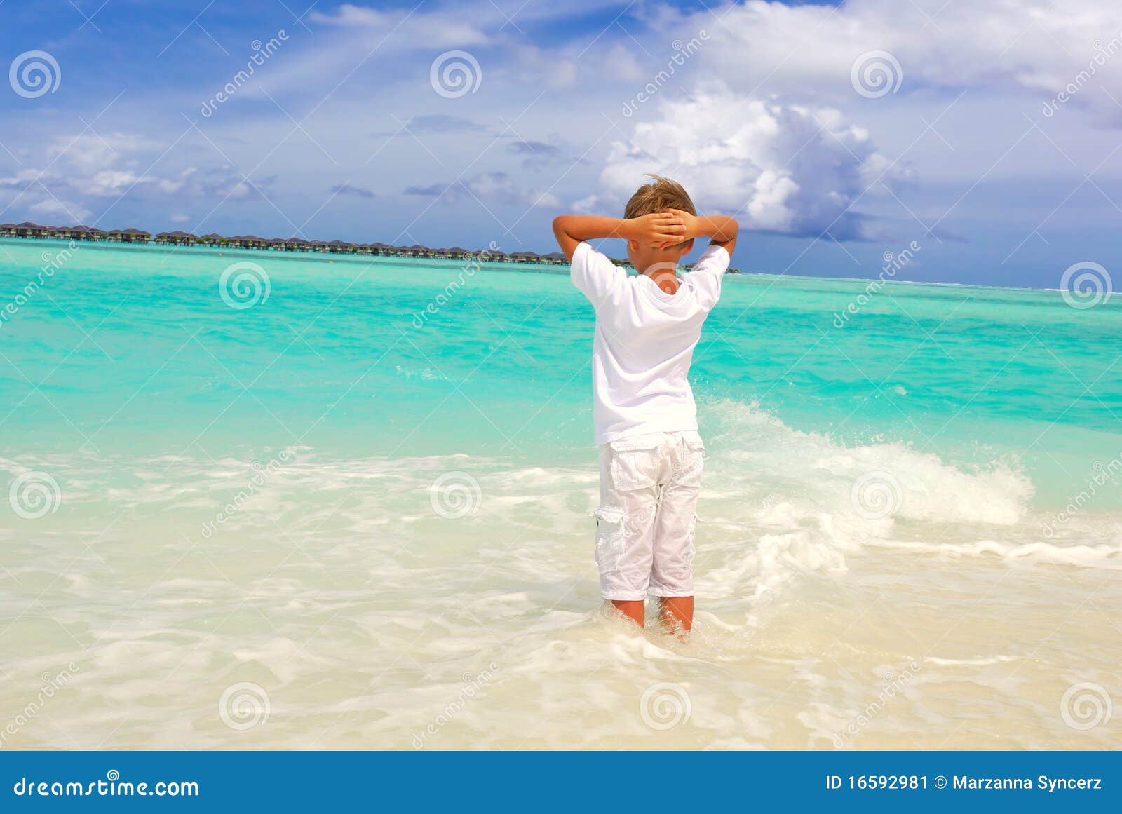 Boy standing in sea stock image. Image of cloudscape - 16592981
