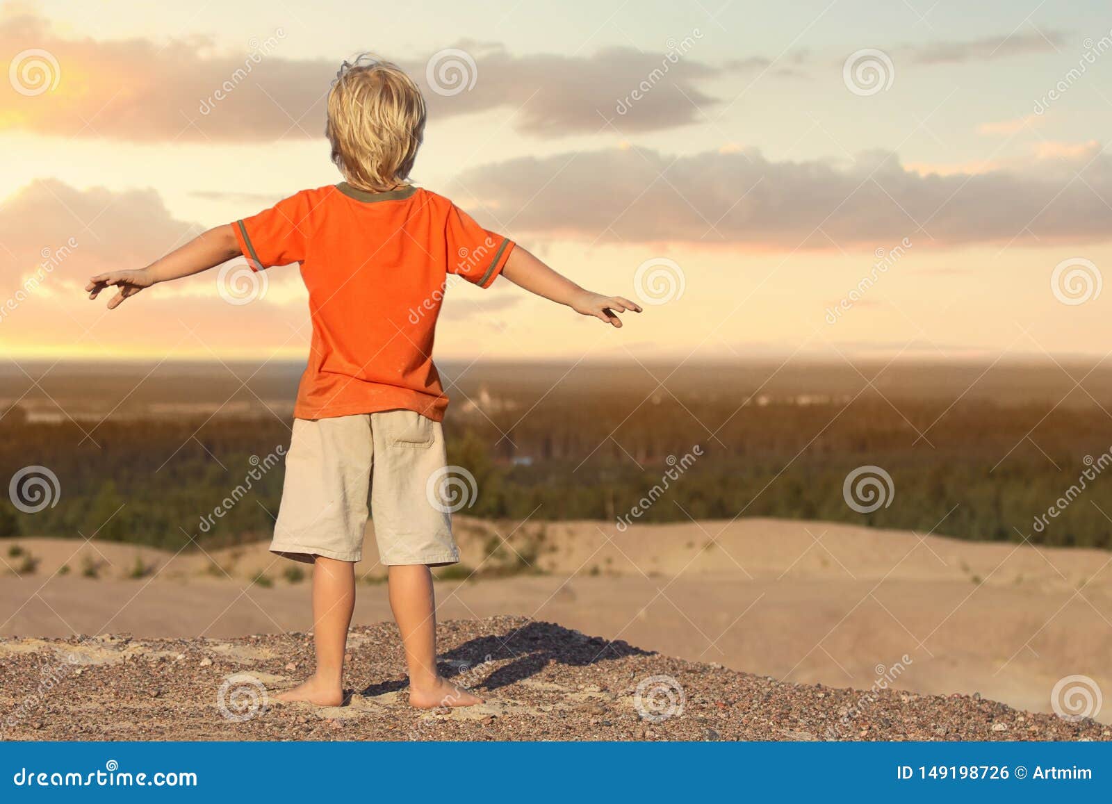 Boy Standing and Watching the Sunset in the Sand Mountain Stock Photo ...