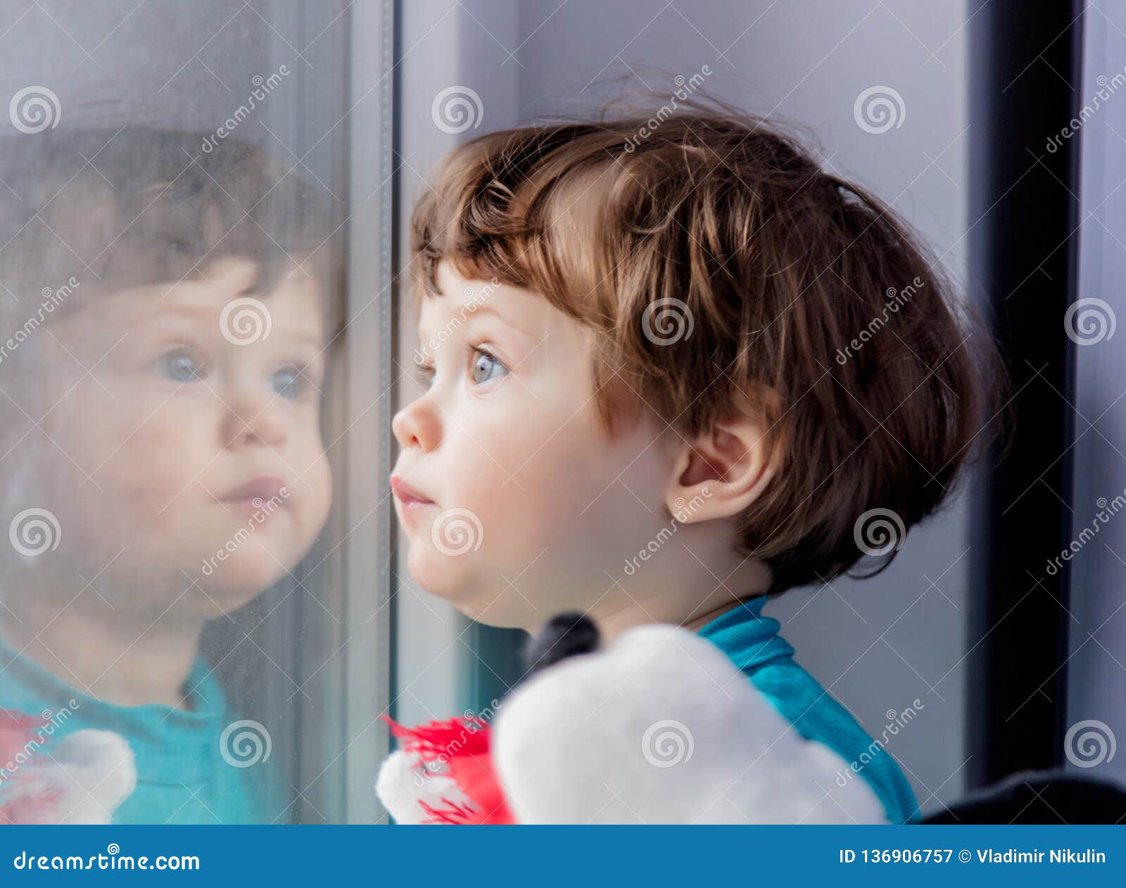 Boy is Standing by the Window and Looking into it Stock Image - Image ...