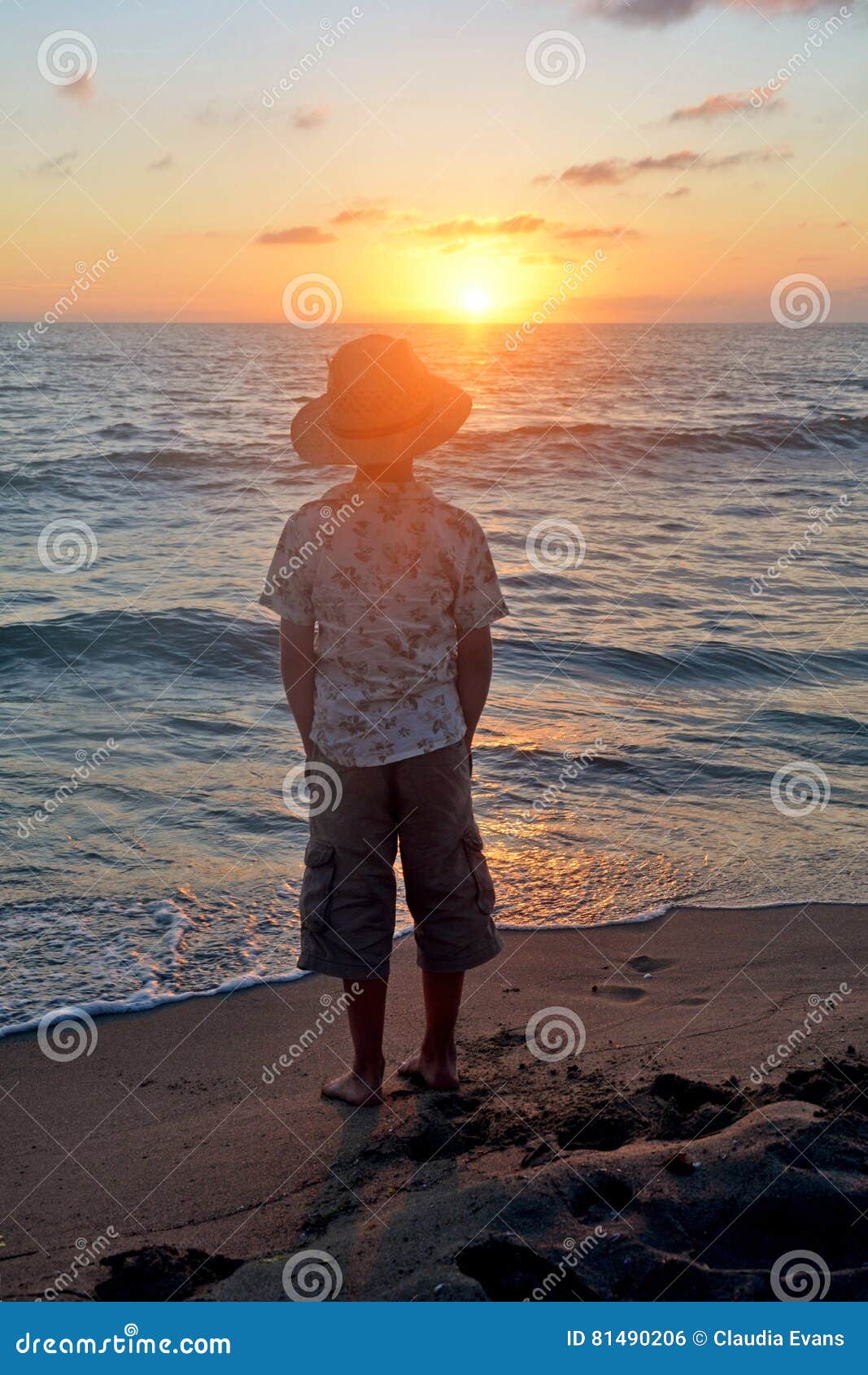 Boy Stands on the Beach at the Sundown and Looks As the Sun Stock Photo ...