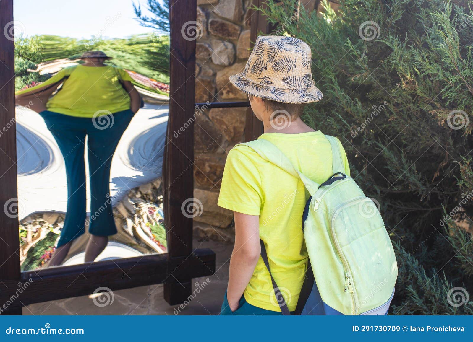 The Boy Stands in Front of a Distorting Mirror. Stock Image - Image of ...