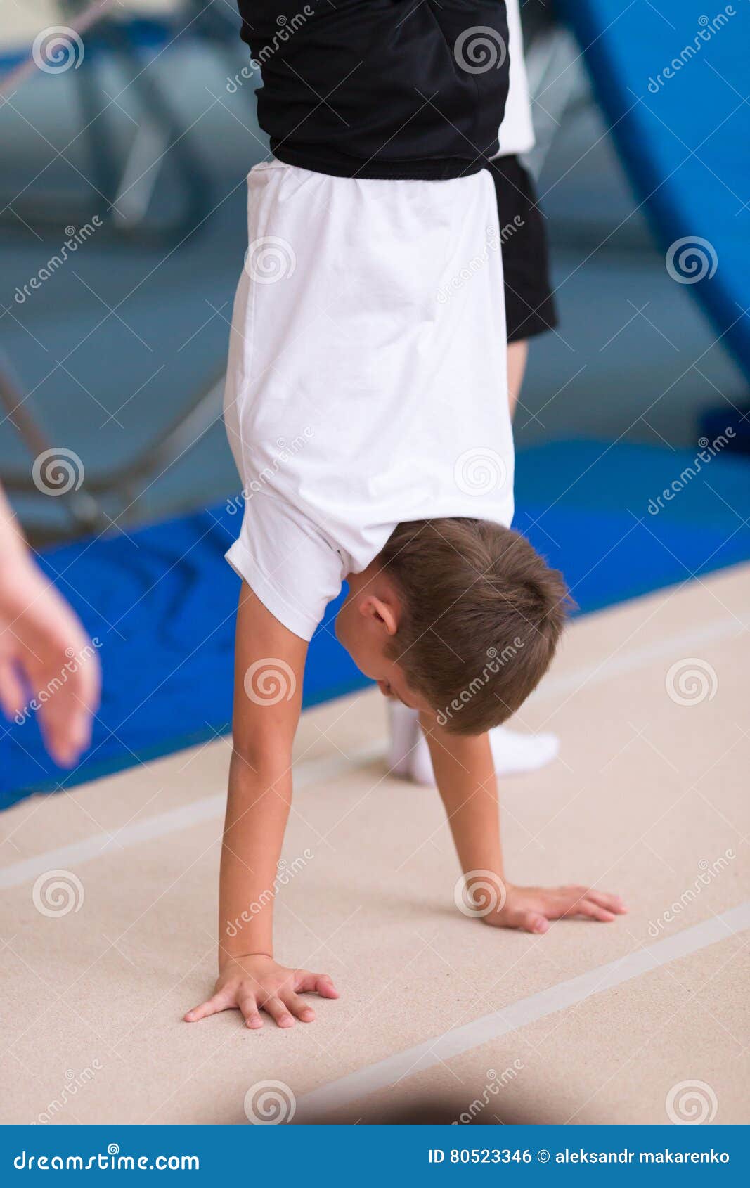 Boy Stands on His Hands in the Gym Stock Photo - Image of little, male ...