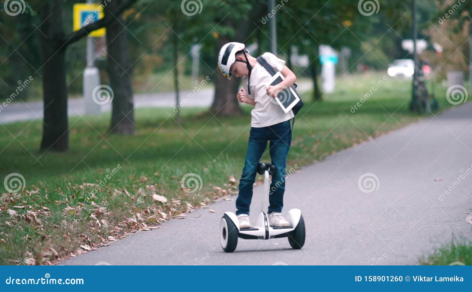 A Boy Stands on a Segway, Takes a Tablet from a Backpack Stock Footage ...