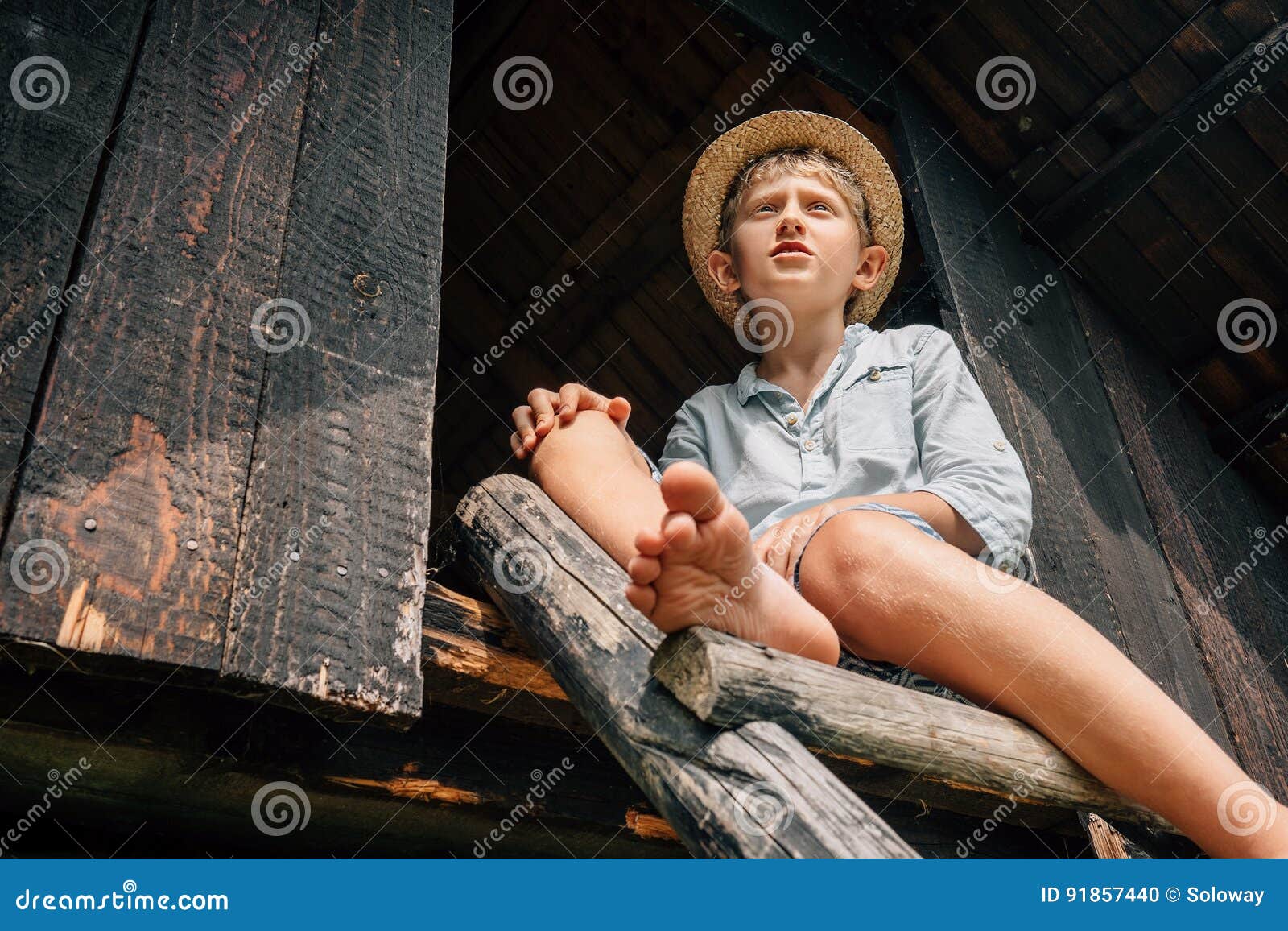 Boy in Straw Hat Sits on the Wood Leader To Barn Stock Photo - Image of ...