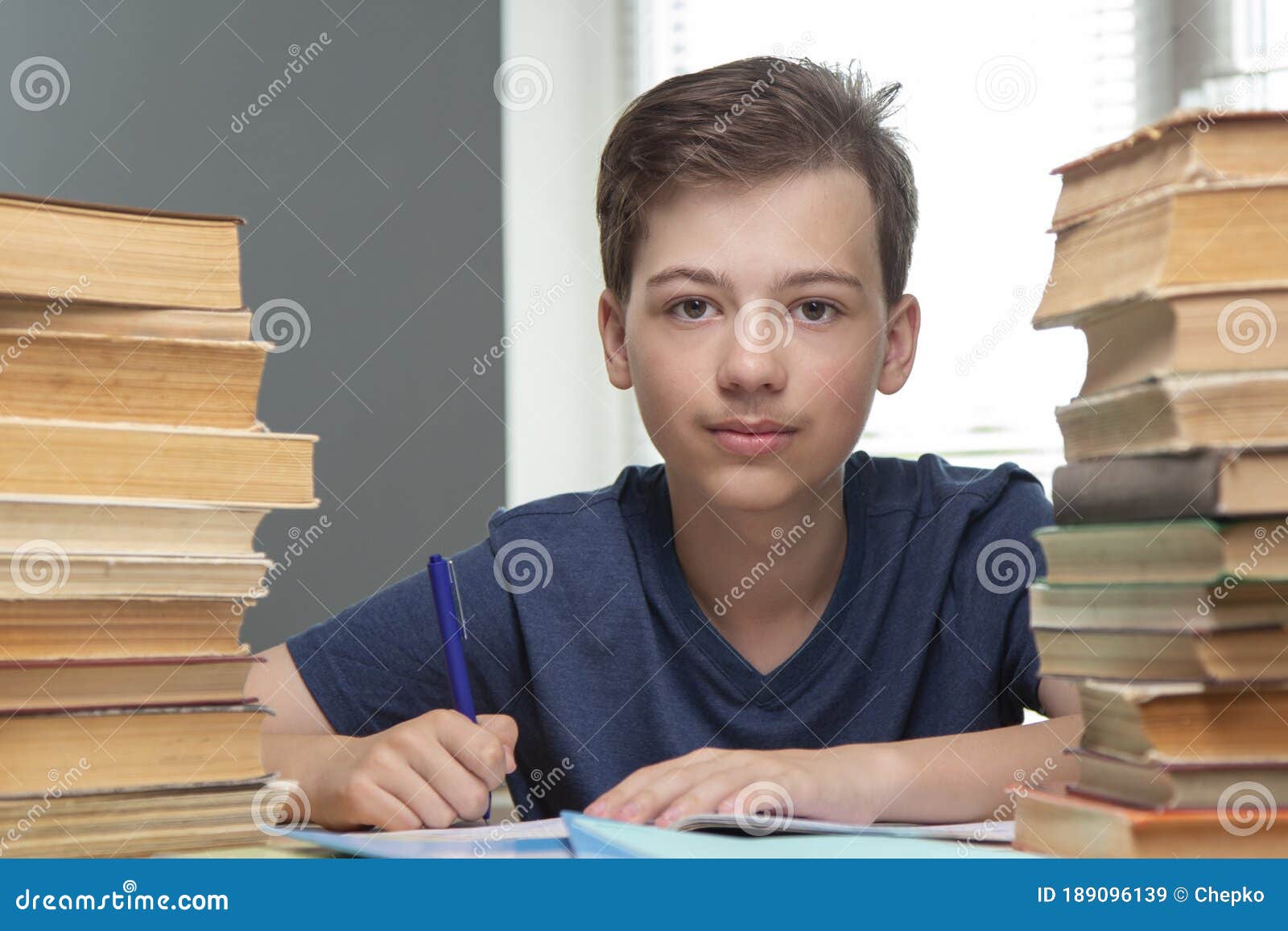 Boy Studing at Table on Blue Background and Many Book Stock Image ...