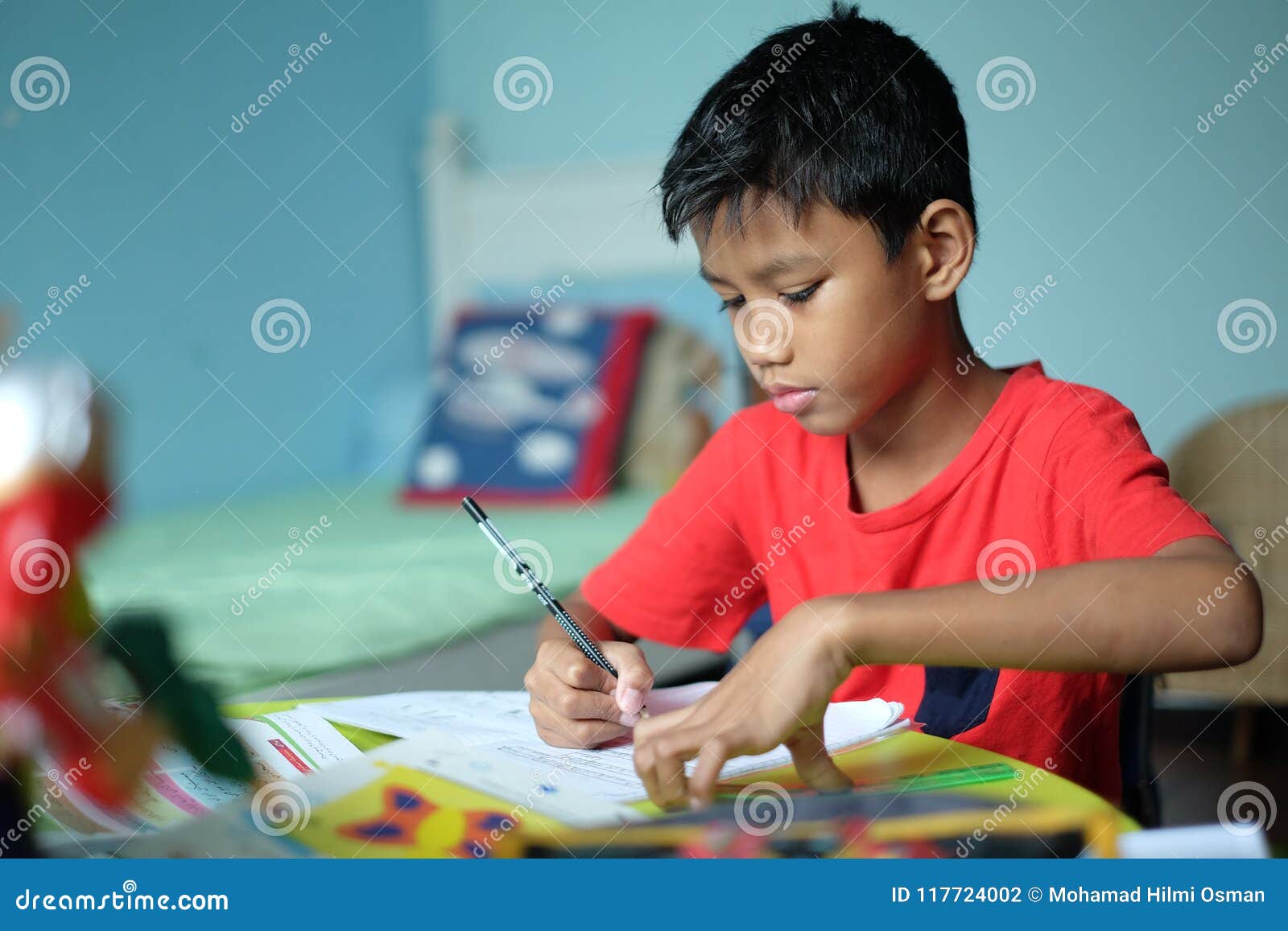A boy study at his bedroom stock photo. Image of pencil - 117724002