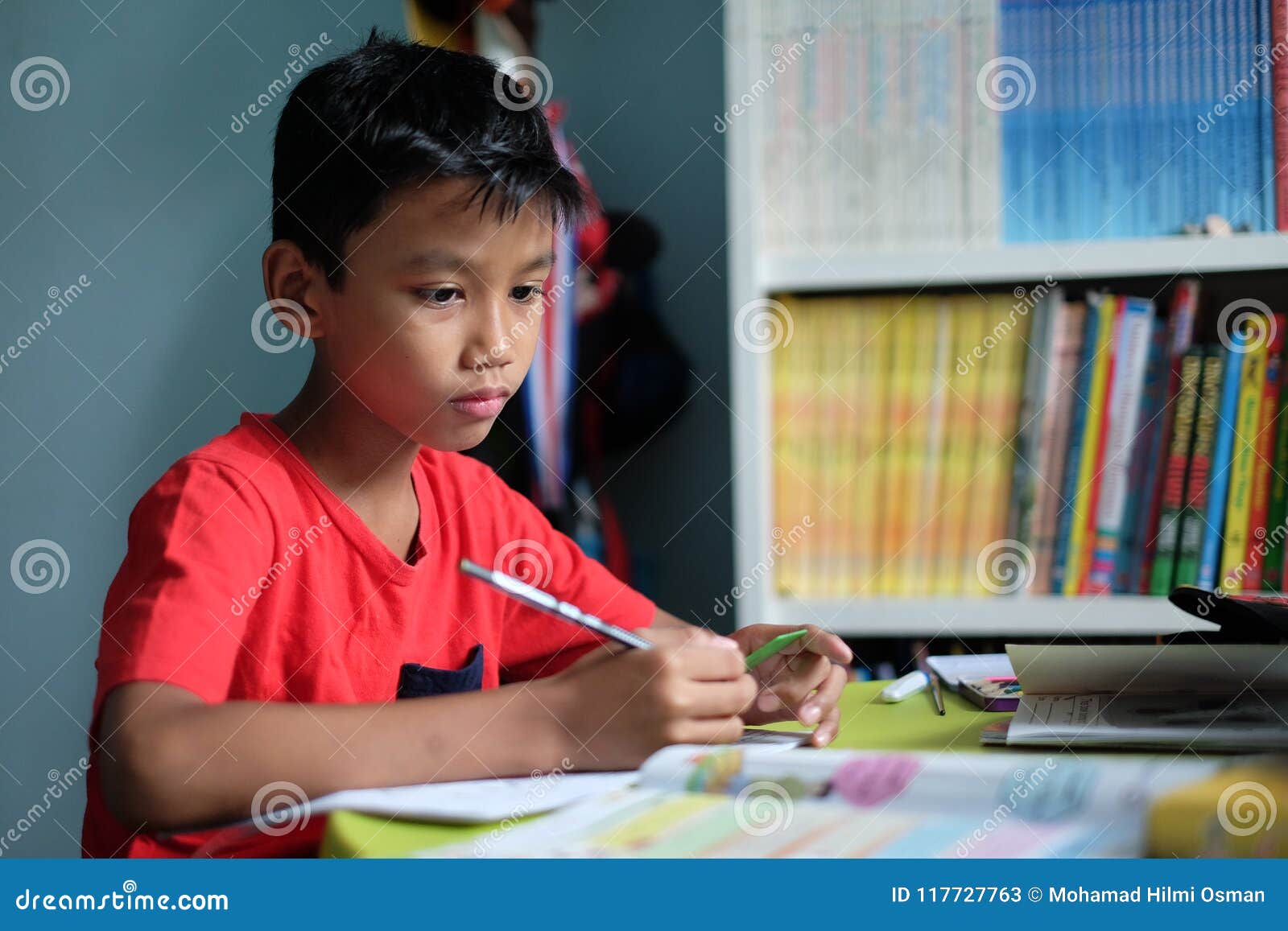 A boy study at his bedroom stock image. Image of reading - 117727763