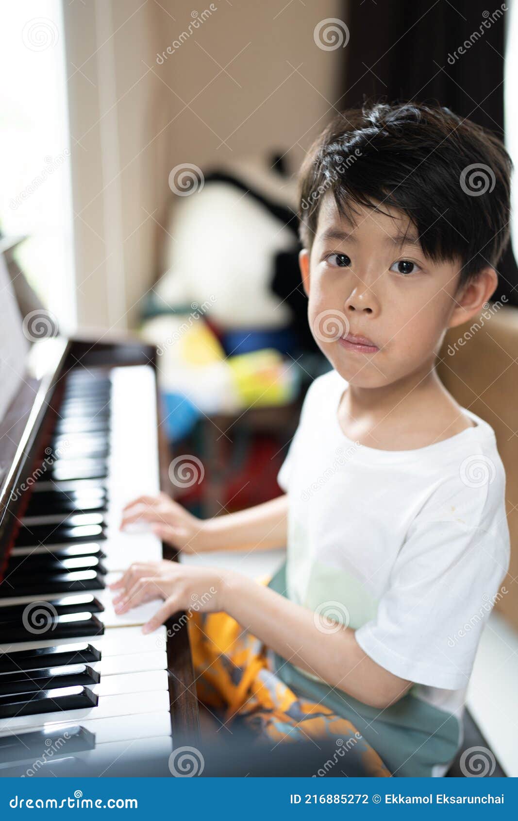 A Boy is Studying Piano Online with Tablet Stock Photo - Image of ...