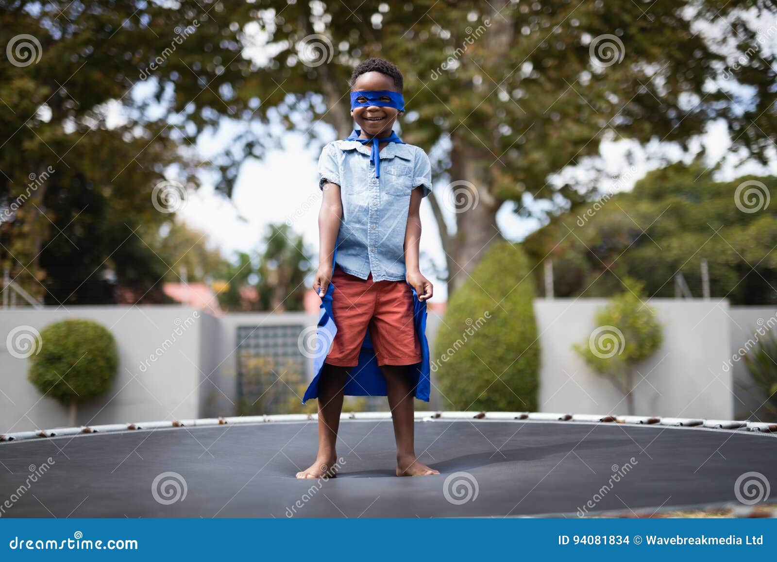 Boy in Superhero Costume Standing on Trampoline Stock Photo - Image of ...