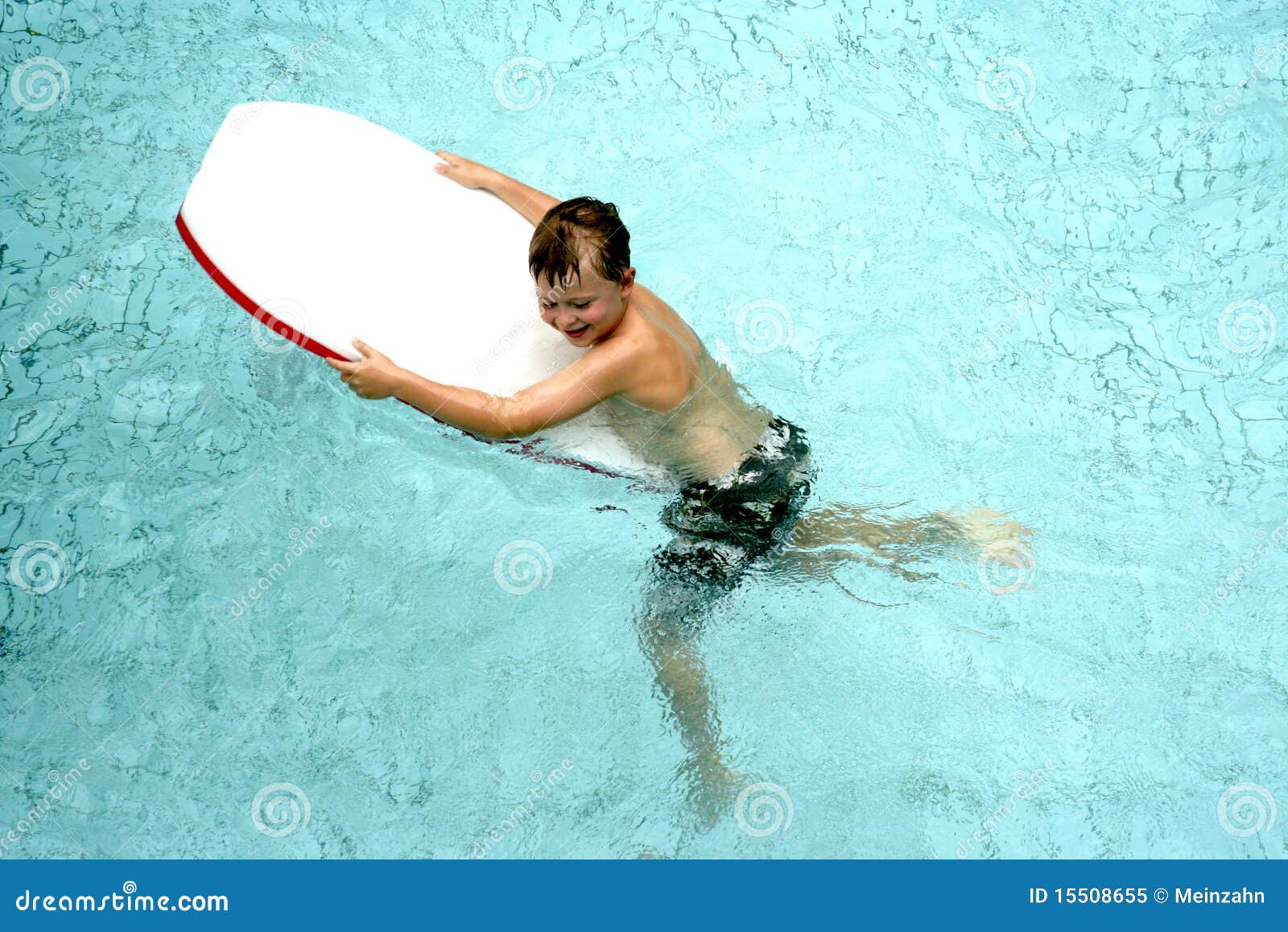 Boy on surfboard in pool stock image. Image of swimming - 15508655
