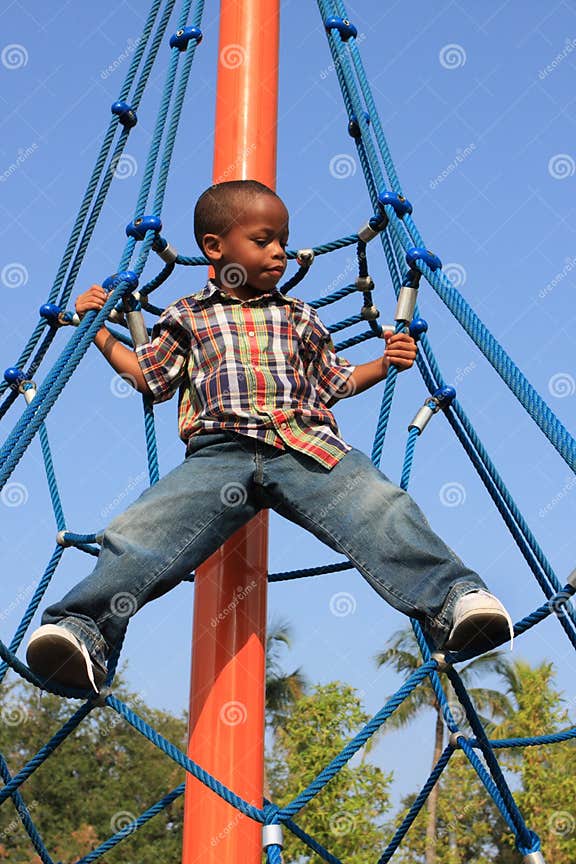 Boy Suspended on Ropes stock image. Image of handsome - 5489391
