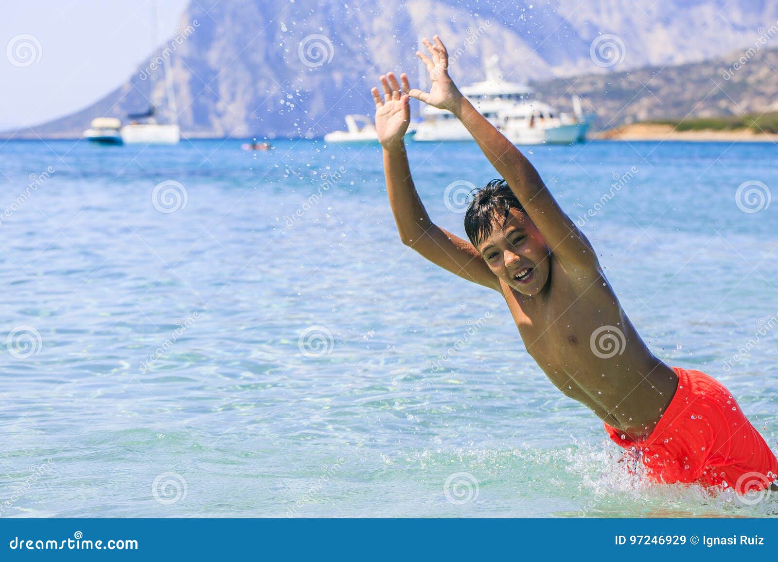 Boy swimming on the beach stock image. Image of exercise - 97246929